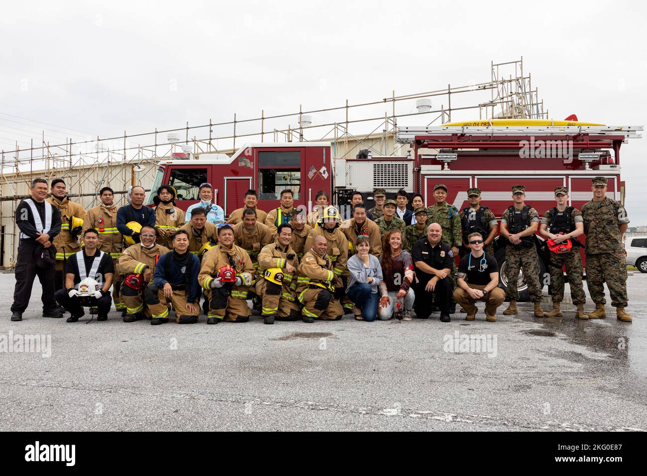 Observers and participants pose for a group photo after a multi-vehicle ...