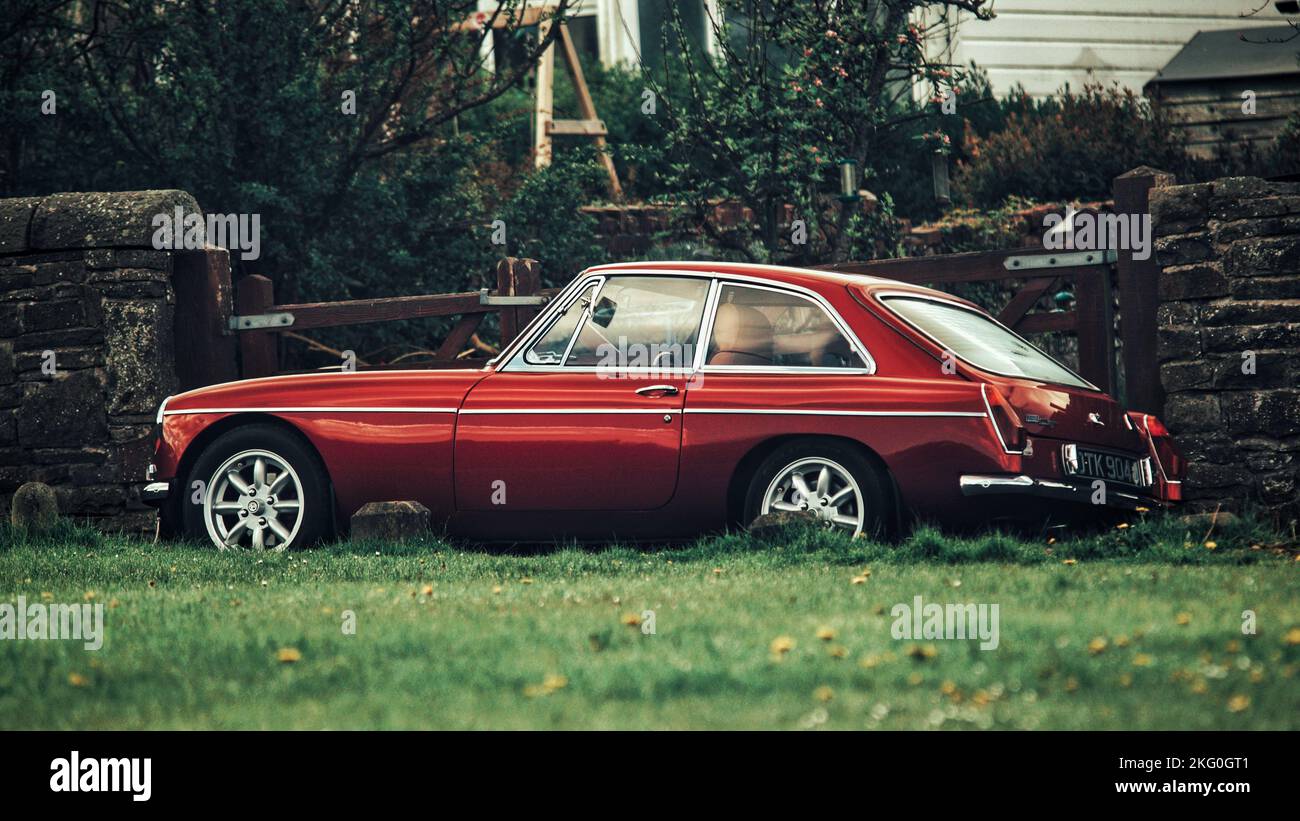 A red MGB car parked on grassland Stock Photo - Alamy