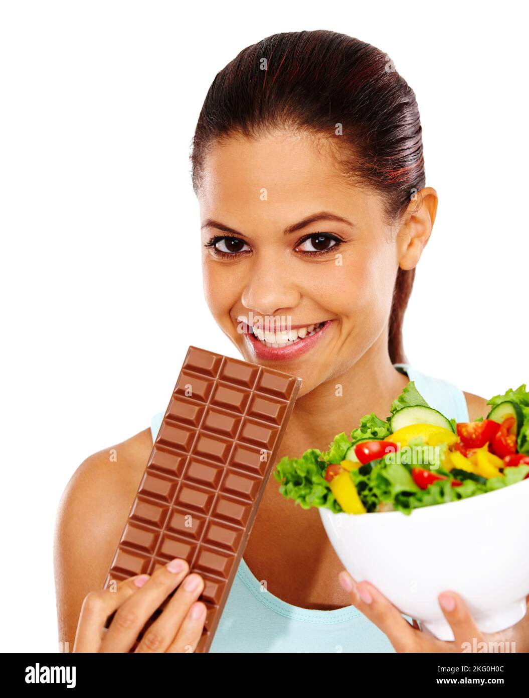 Cheating on her diet. Portrait of an attractive young woman being ...