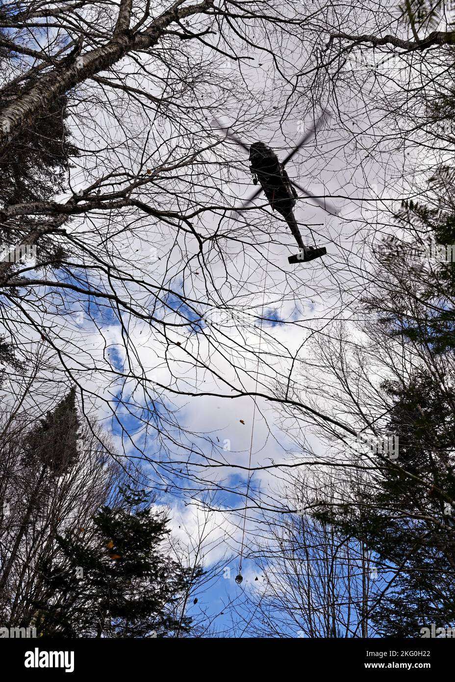 A New Hampshire Army National Guard Black Hawk helicopter lowers a 130 ...