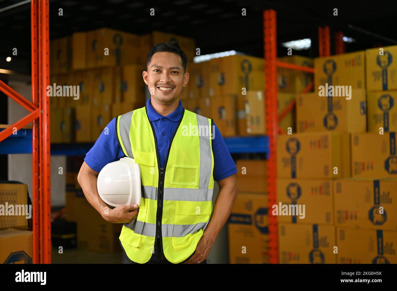 Smart and handsome millennial Asian male factory engineer or warehouse ...