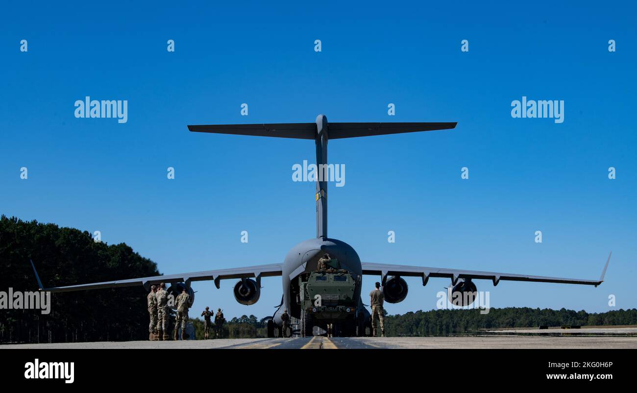 U.S. Airmen and Marines prepare to load a High Mobility Artillery ...