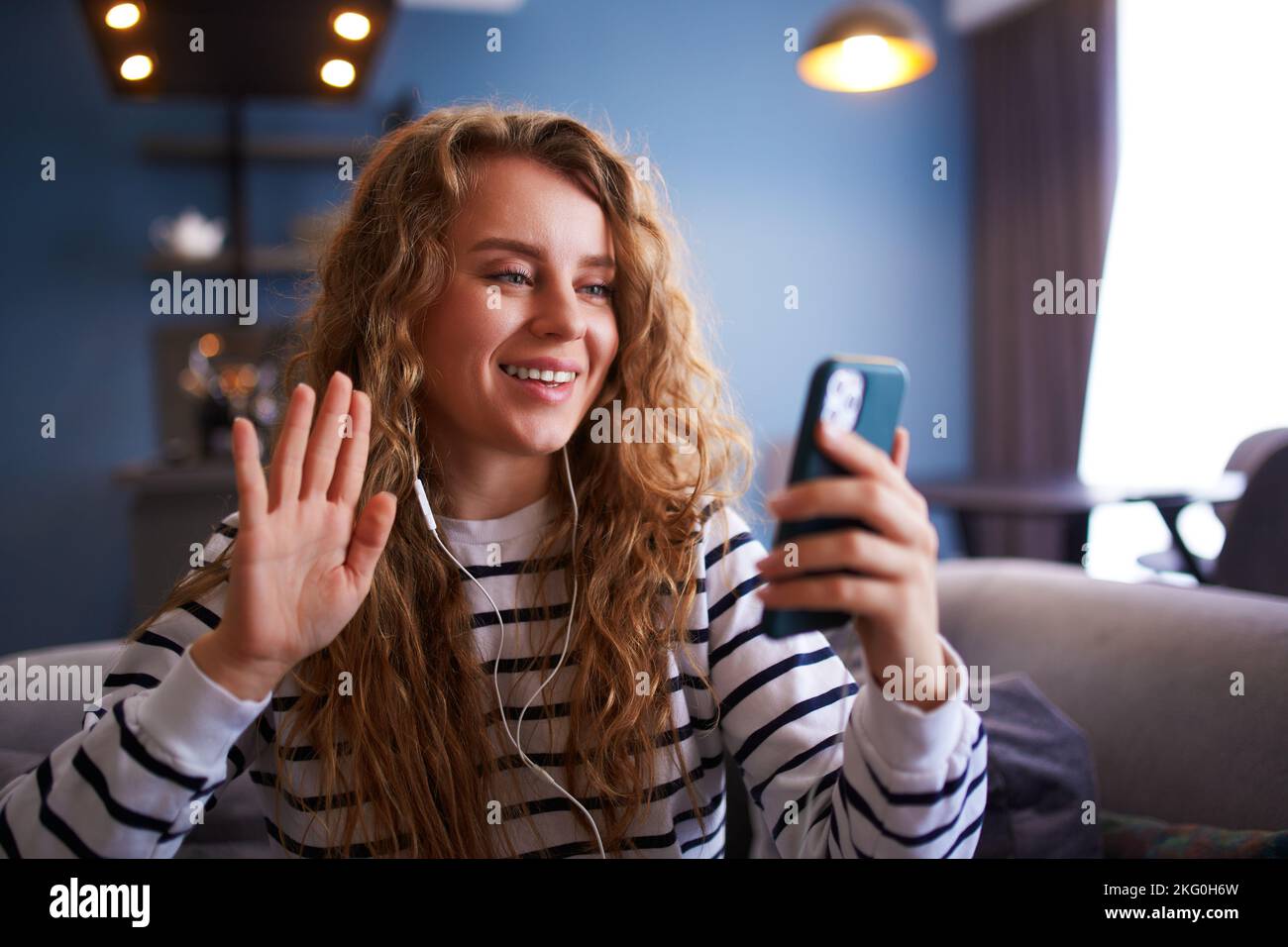 Woman talking on video chat conference with friends on smartphone ...
