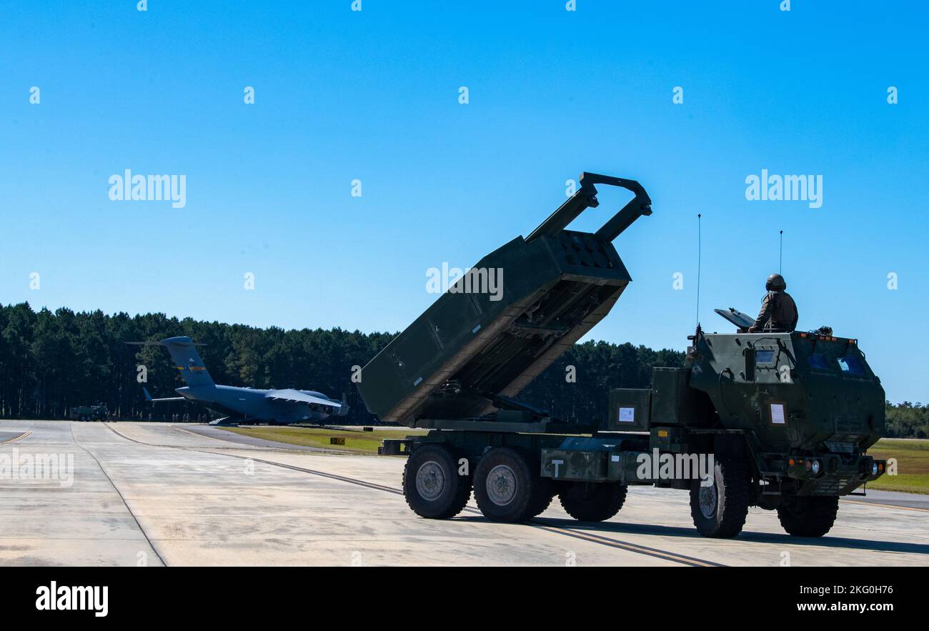 U.S. Marines prepare to load a High Mobility Artillery Rocket System ...