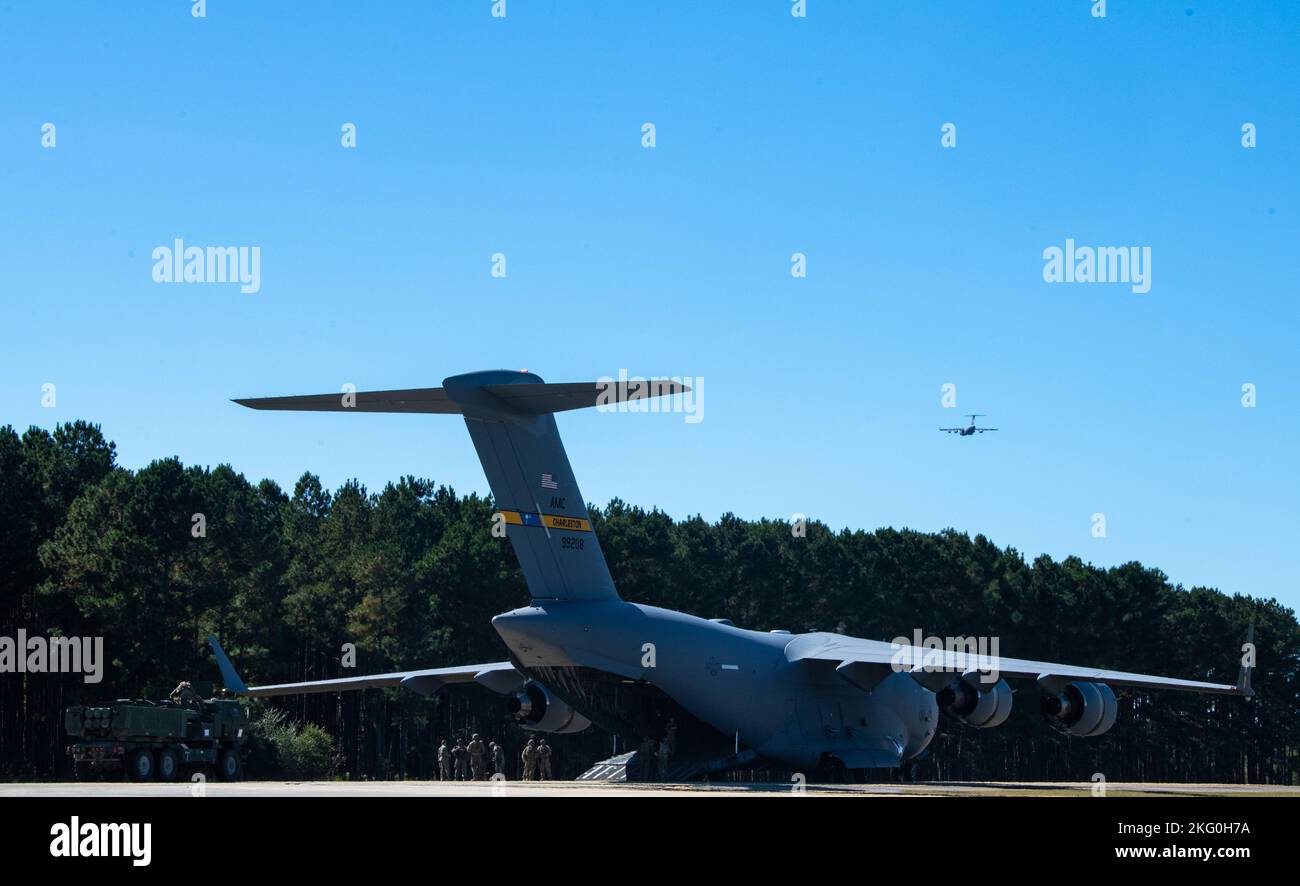 U.S. Marines prepare to load a High Mobility Artillery Rocket System ...
