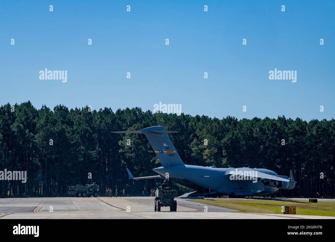 U.S. Marines prepare to load a High Mobility Artillery Rocket System, known as HIMARS, onto a C ...