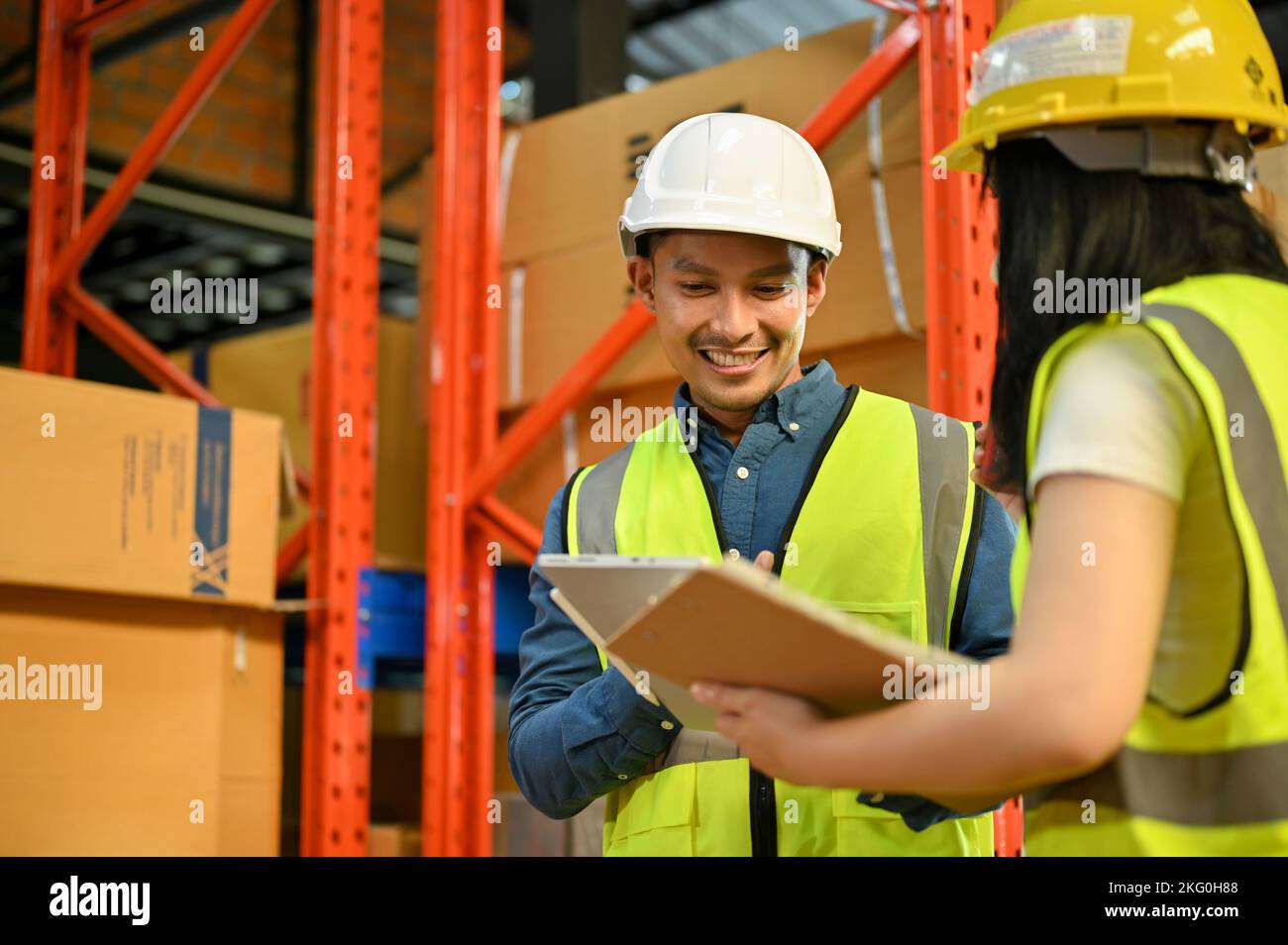 Professional millennial Asian male warehouse supervisor working with ...