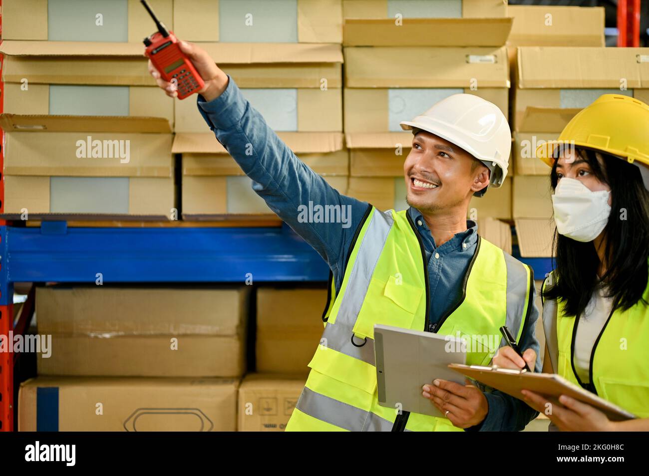 Professional and cheerful millennial Asian male warehouse supervisor ...