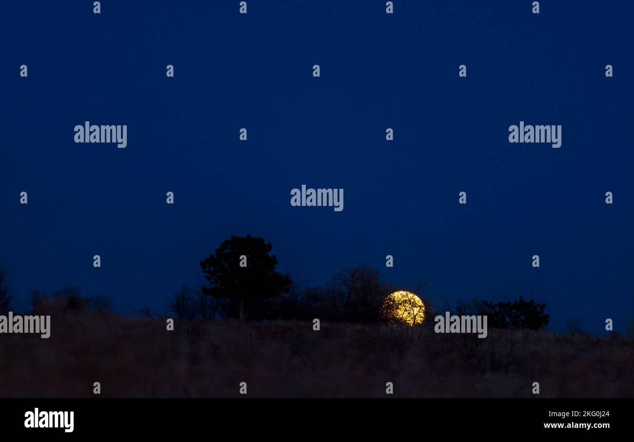 Moonrise above the prairie in Colorado. The moon entering the full moon ...