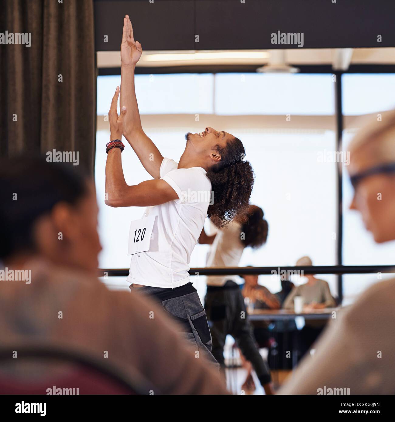 Dancing his heart out. a young male dancer performing before the judges ...