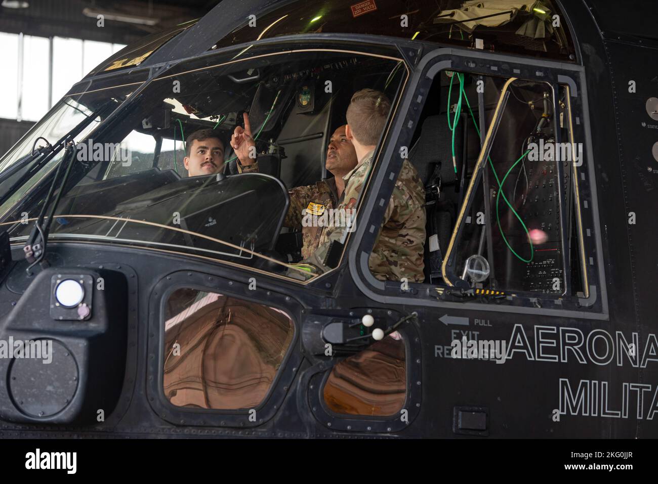 An Italian Air Force member explains HH-101A helicopter features to U.S ...