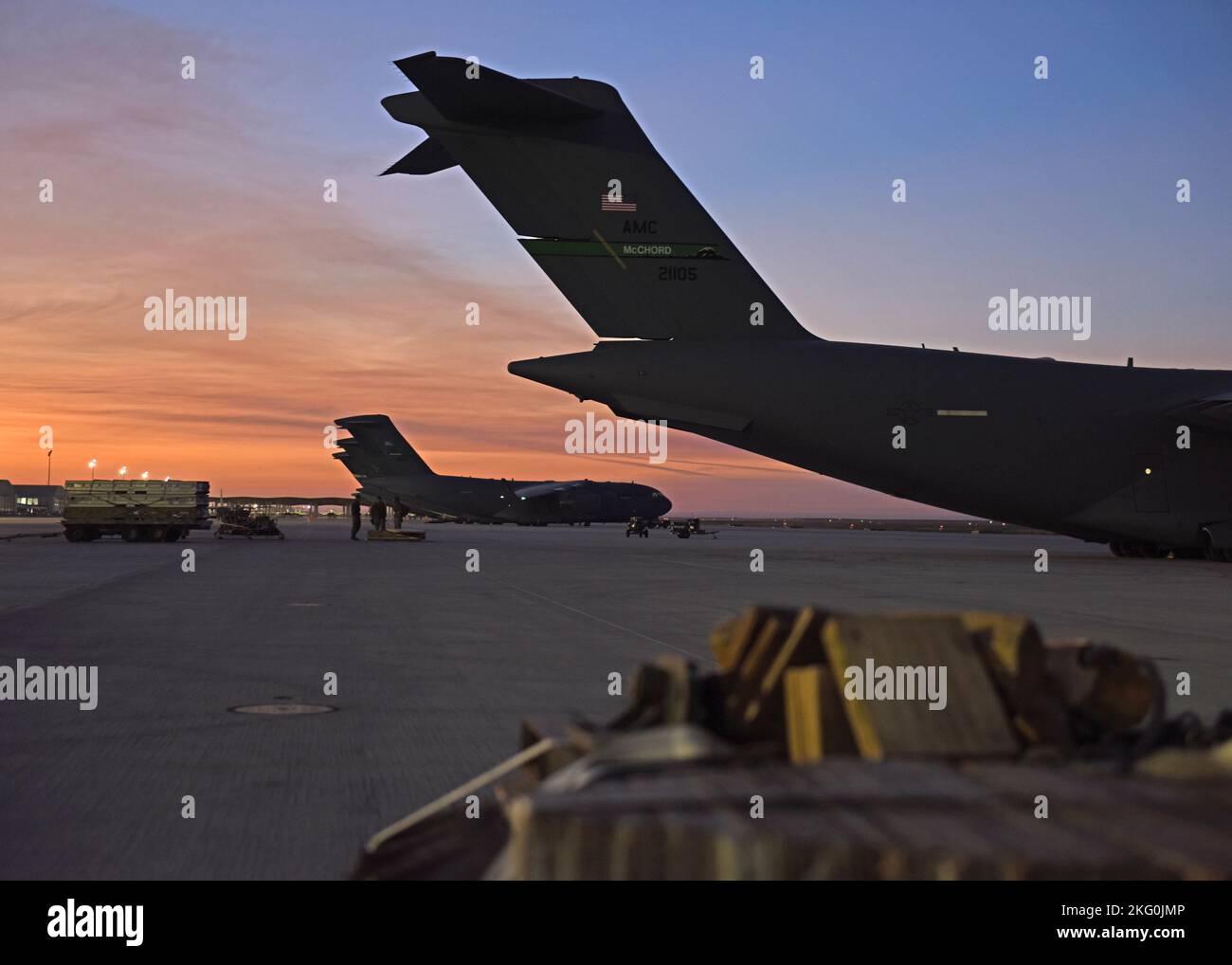 U.S. Airmen with the 62d Maintenance Group prepare to load cargo onto a ...