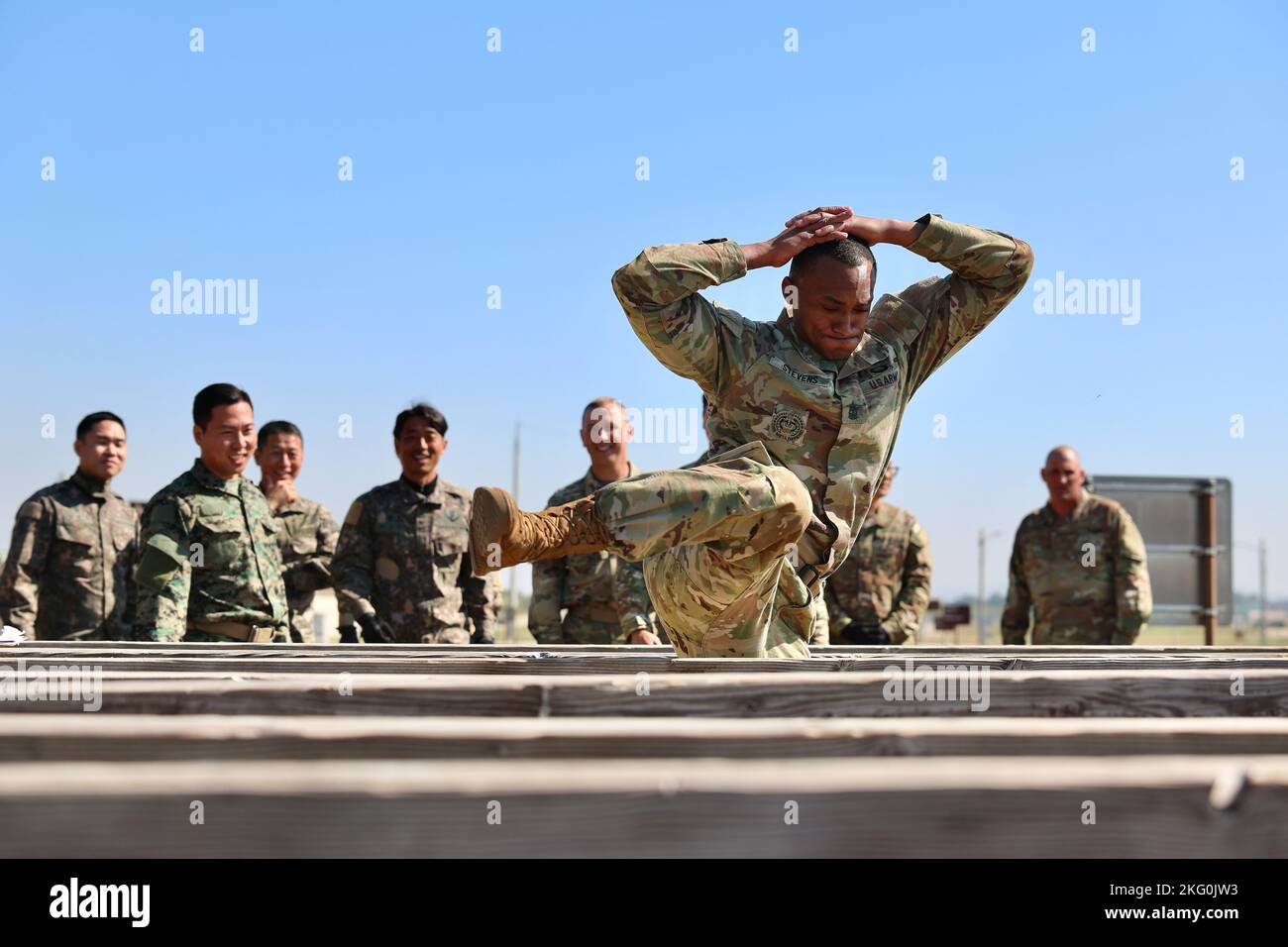 First Sgt. Christopher Stevens negotiates the high hurdle obstacle at ...