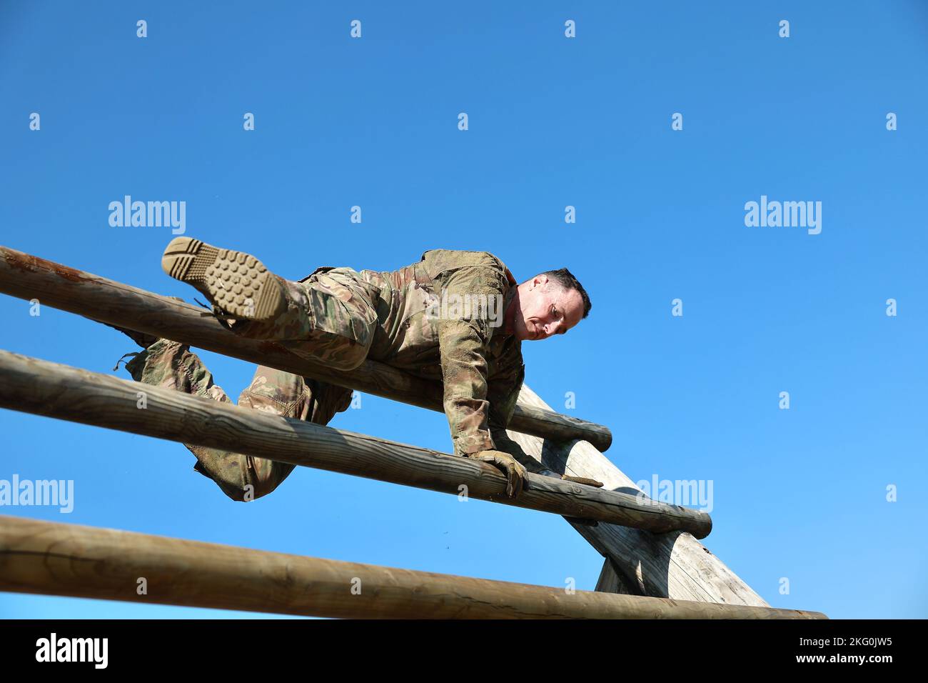 Master Sgt. Joseph Cole vaults climbs over an obstacle at the Camp ...