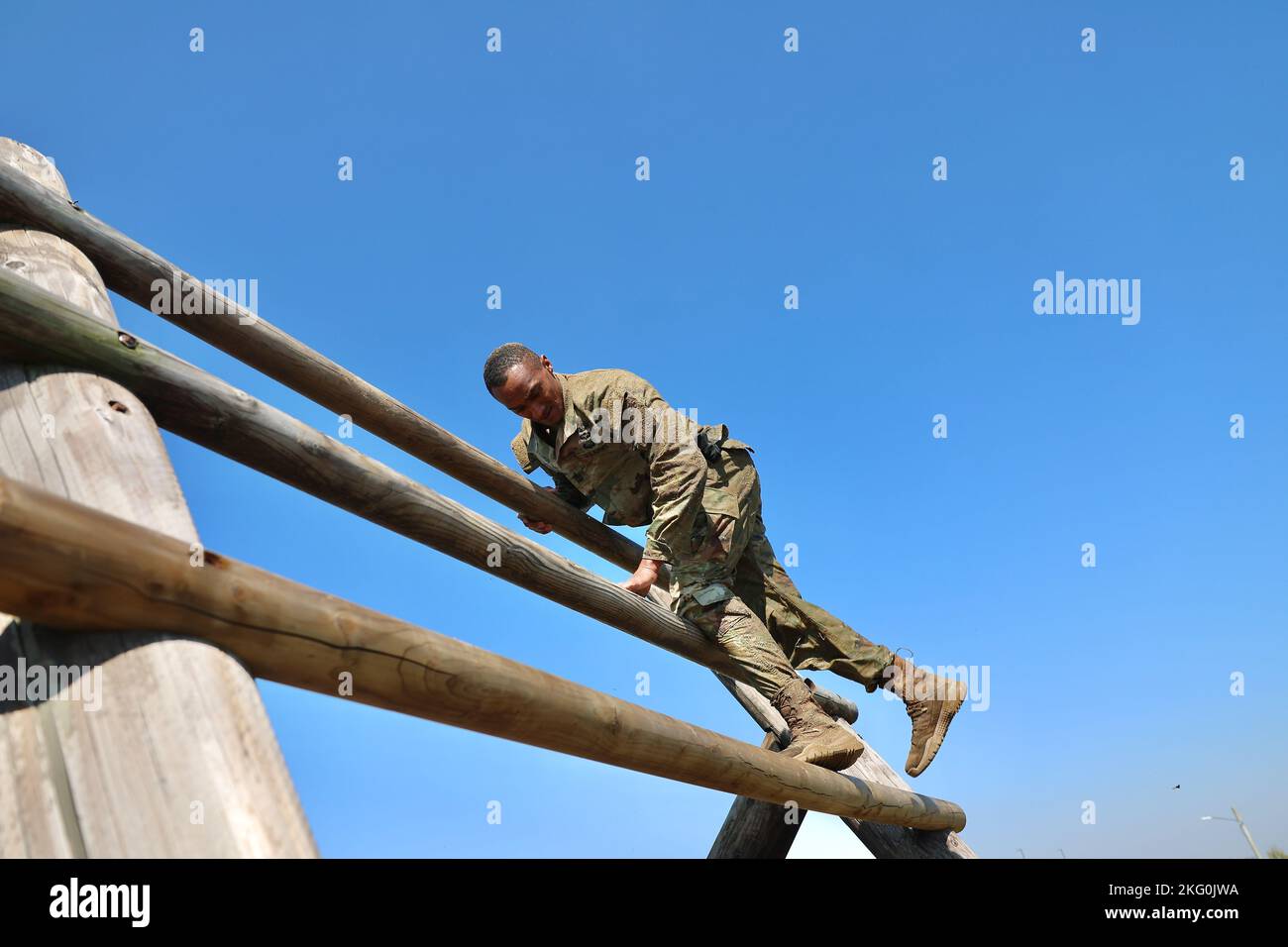 First Sgt. Christopher Stevens vaults climbs over an obstacle at the ...
