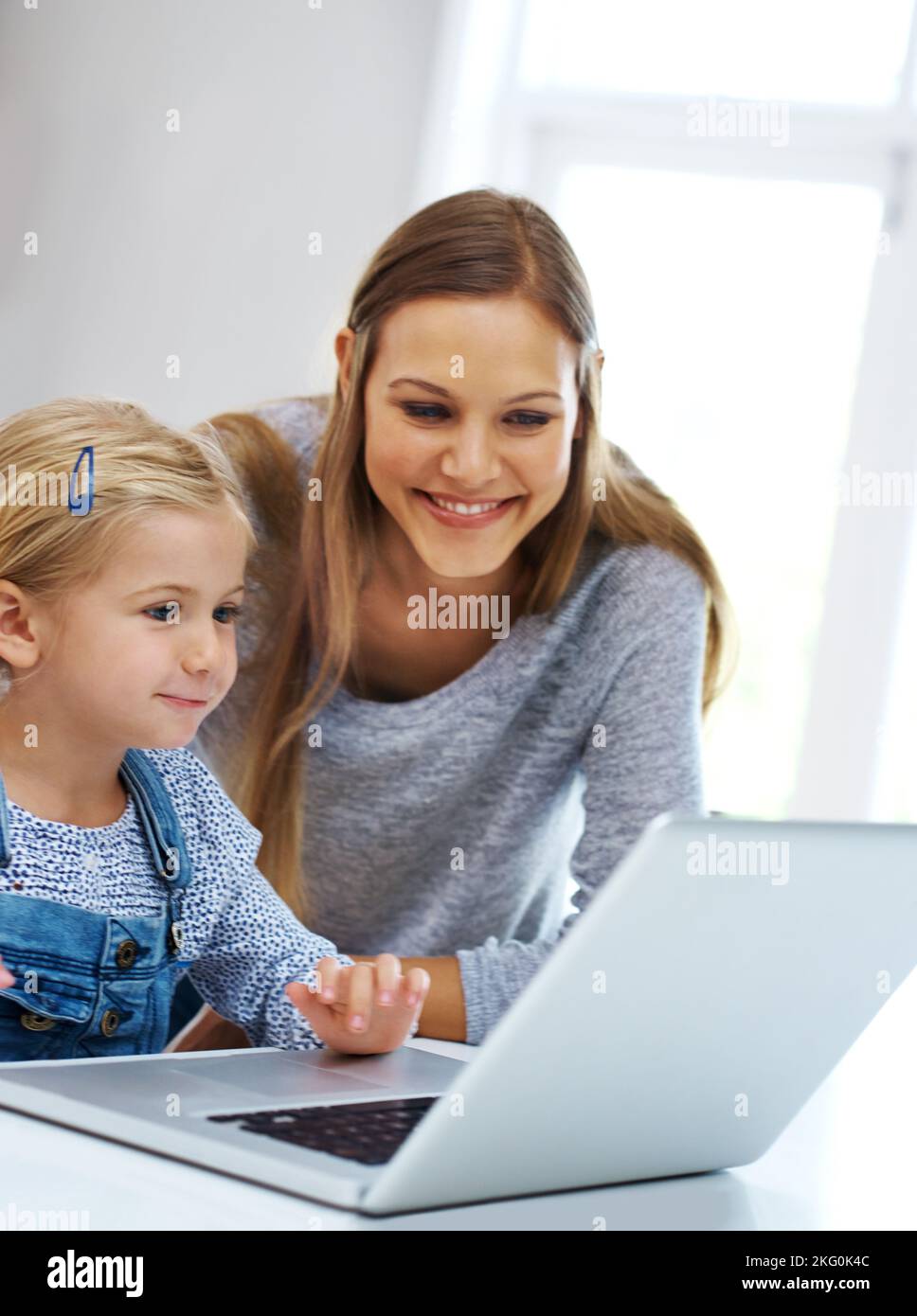 Learning by doing. a happy mother helping her little girl with the ...
