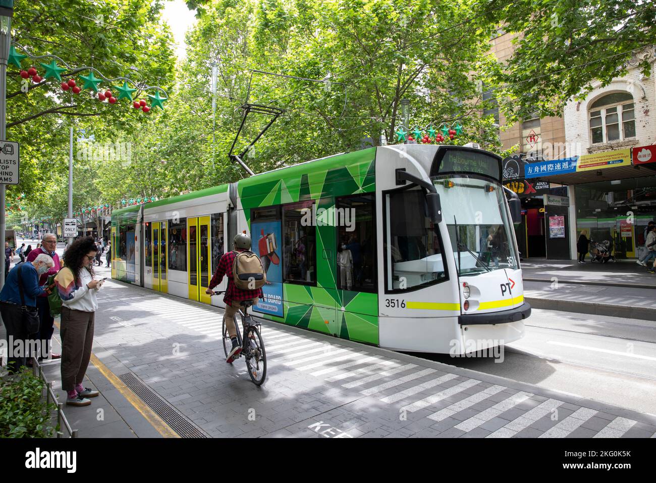 Melbourne city centre, cyclist rides past a Melbourne tram,Victoria ...