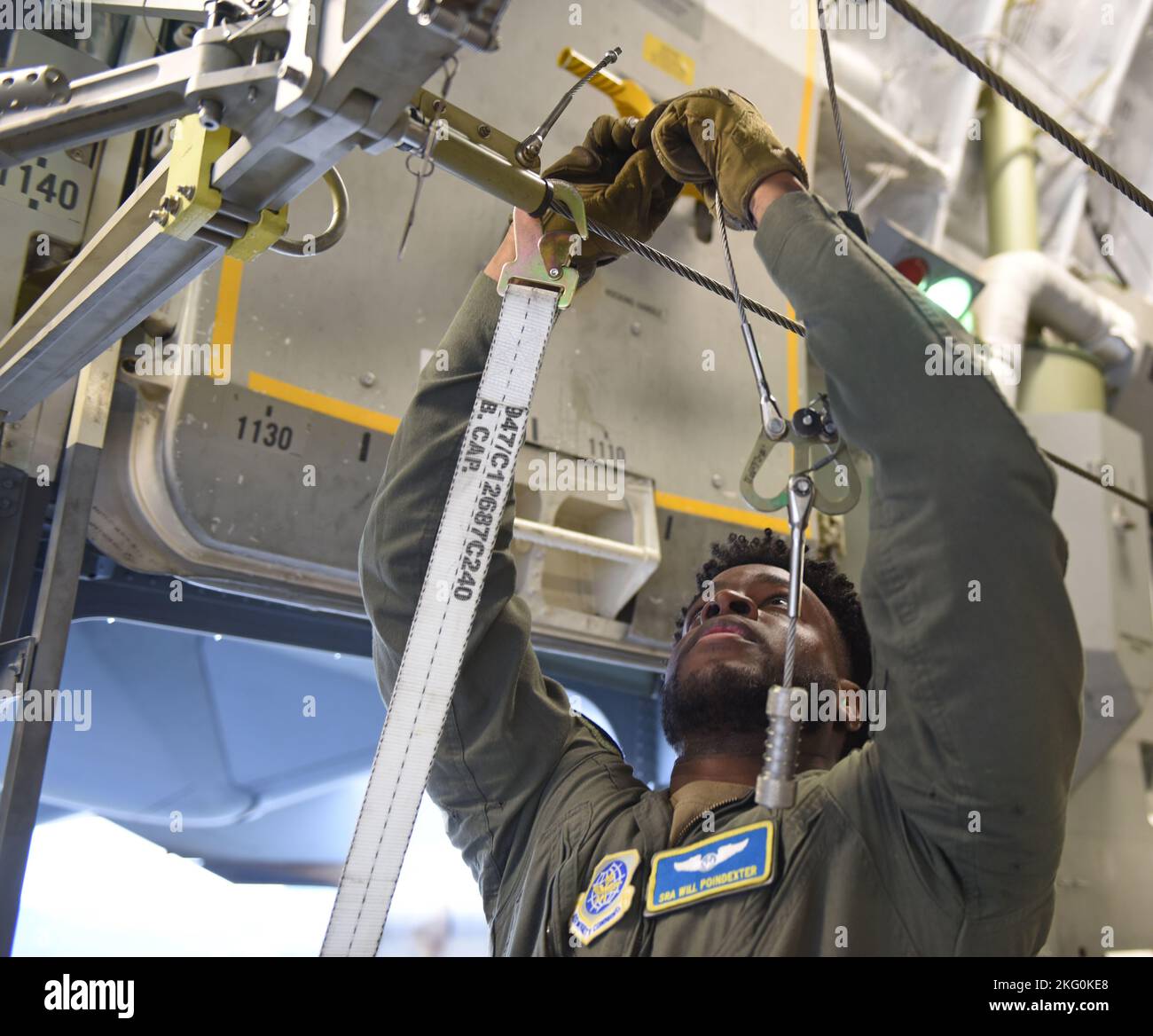 U.S. Air Force Senior Airman Will Poindexter, a loadmaster with the 7th Airlift Squadron, rigs ...