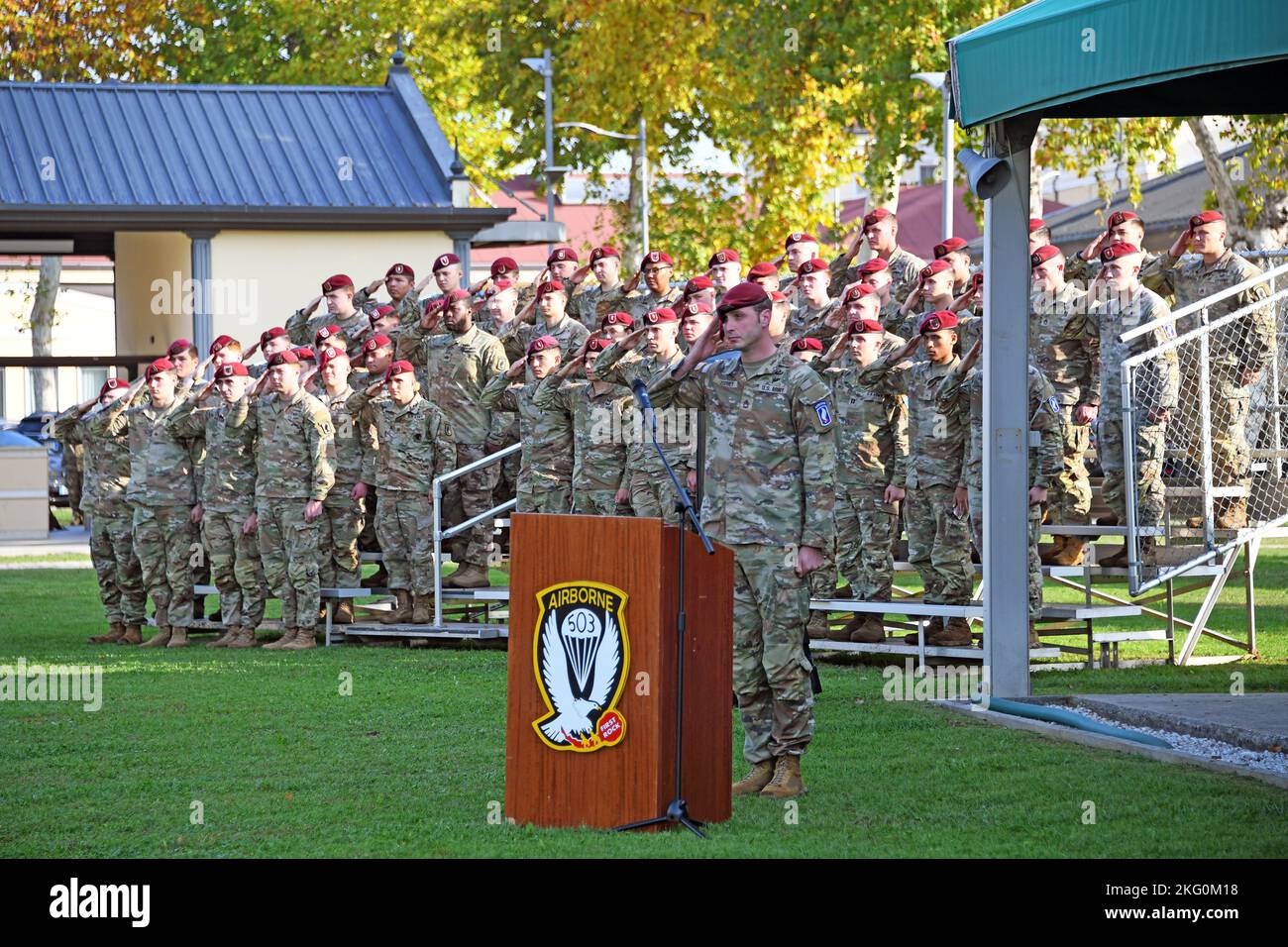 Soldiers from U.S. and Italian units render a salute while the Italian ...
