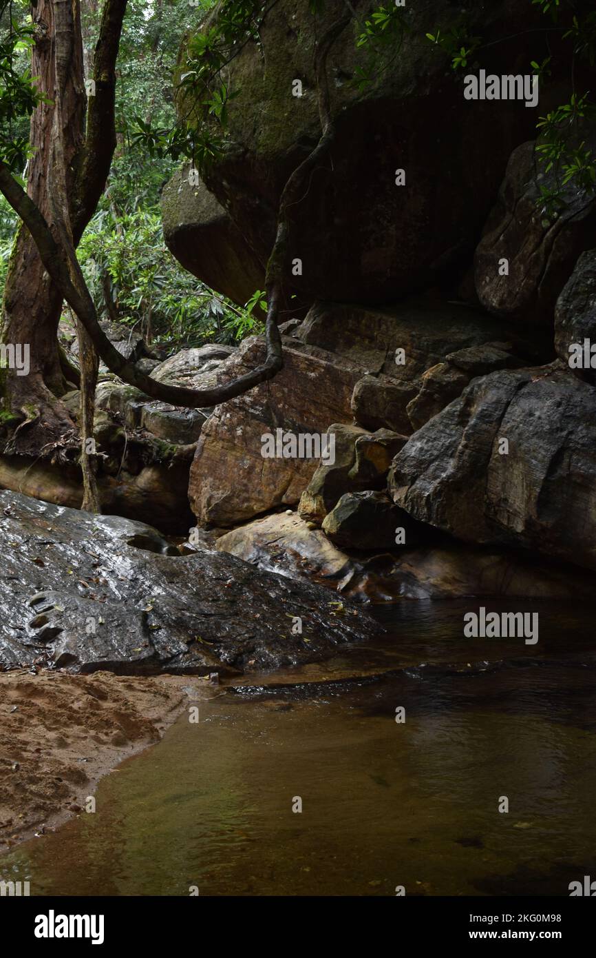 A river surrounded by rocks Stock Photo - Alamy