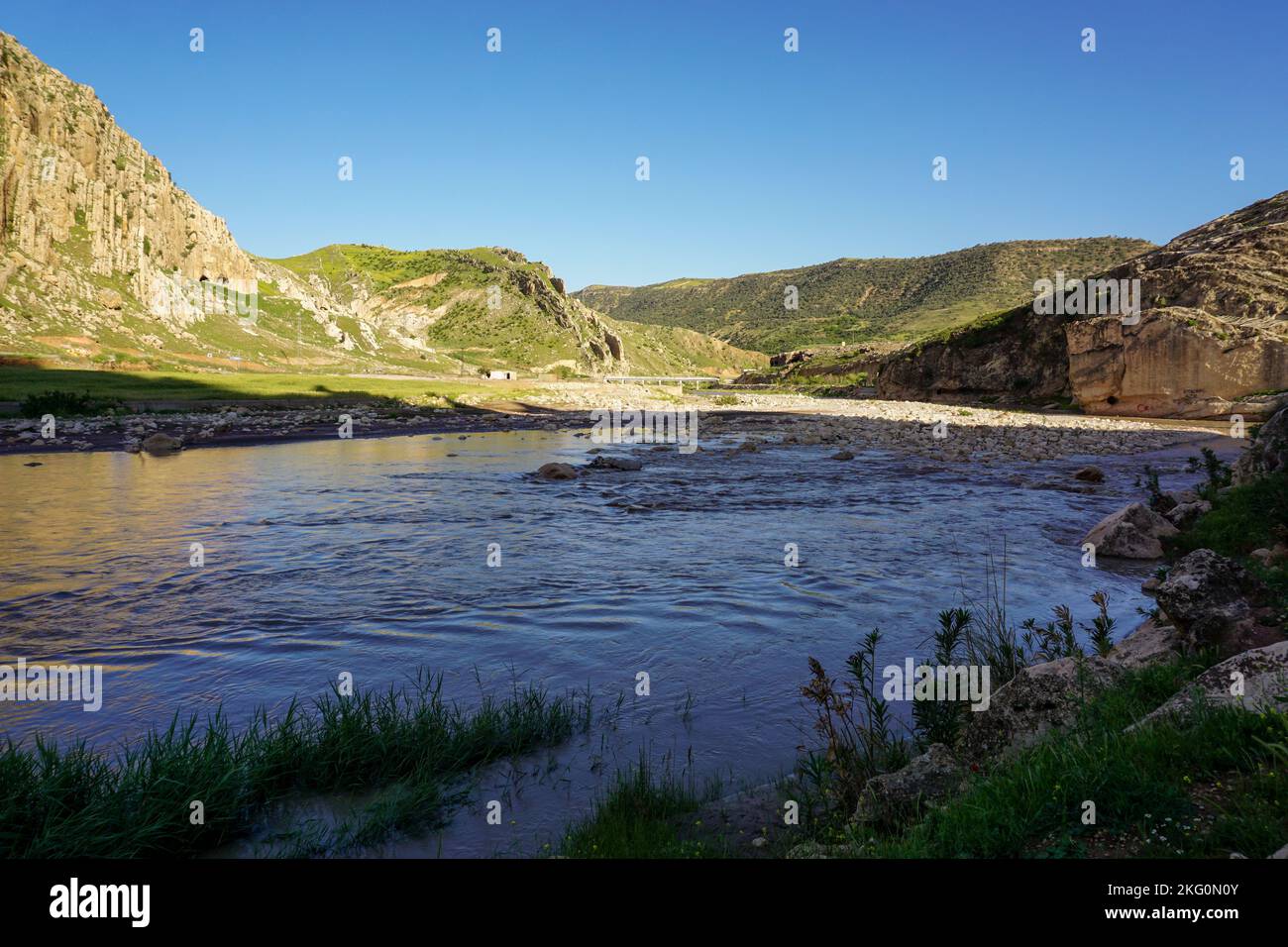 An aerial view of Cudi Gabar mountains surrounded by water under blue ...