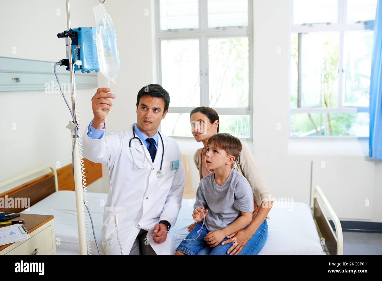 Im going to make you feel better. a mother son and doctor looking at a ...