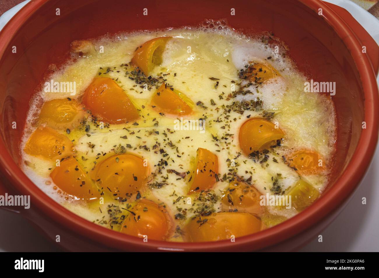 Baked Fiordilatte Cheese With Yellow Tomatoes Stock Photo - Alamy