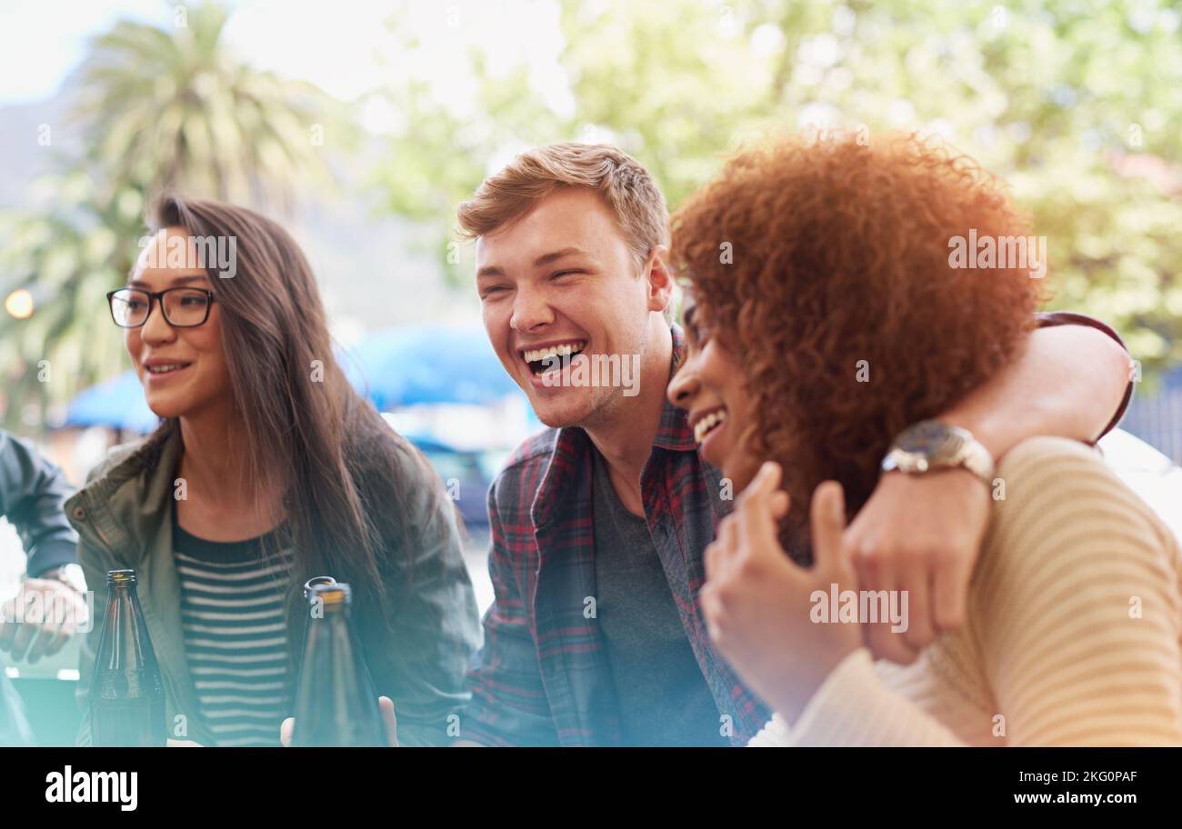 Hanging out with the gang. a group of friends drinking outdoors Stock ...