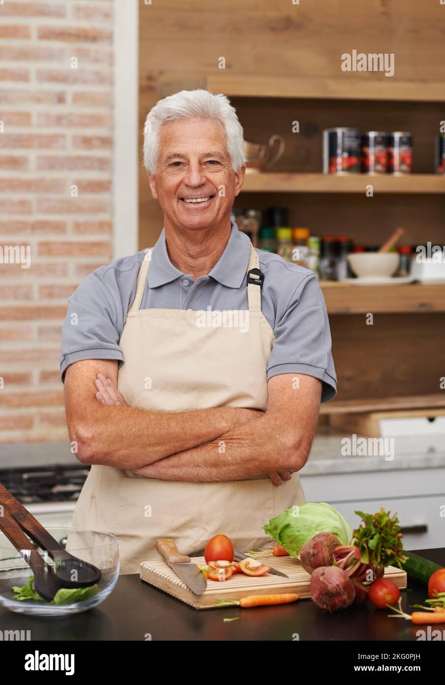I think I wear this kitchen well. a senior man posing happily in a ...
