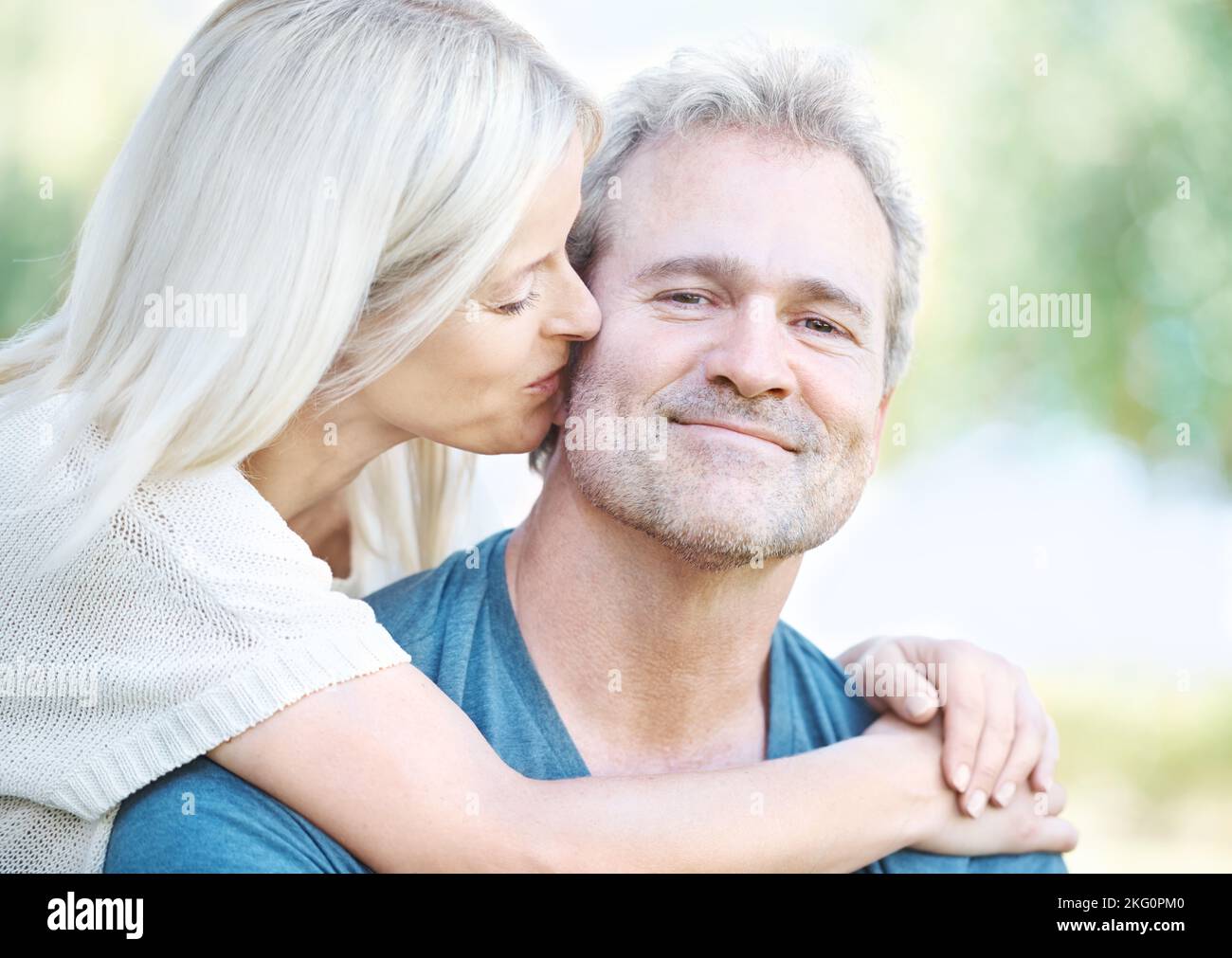 You make my life complete. A handsome man enjoying a kiss on the cheek ...