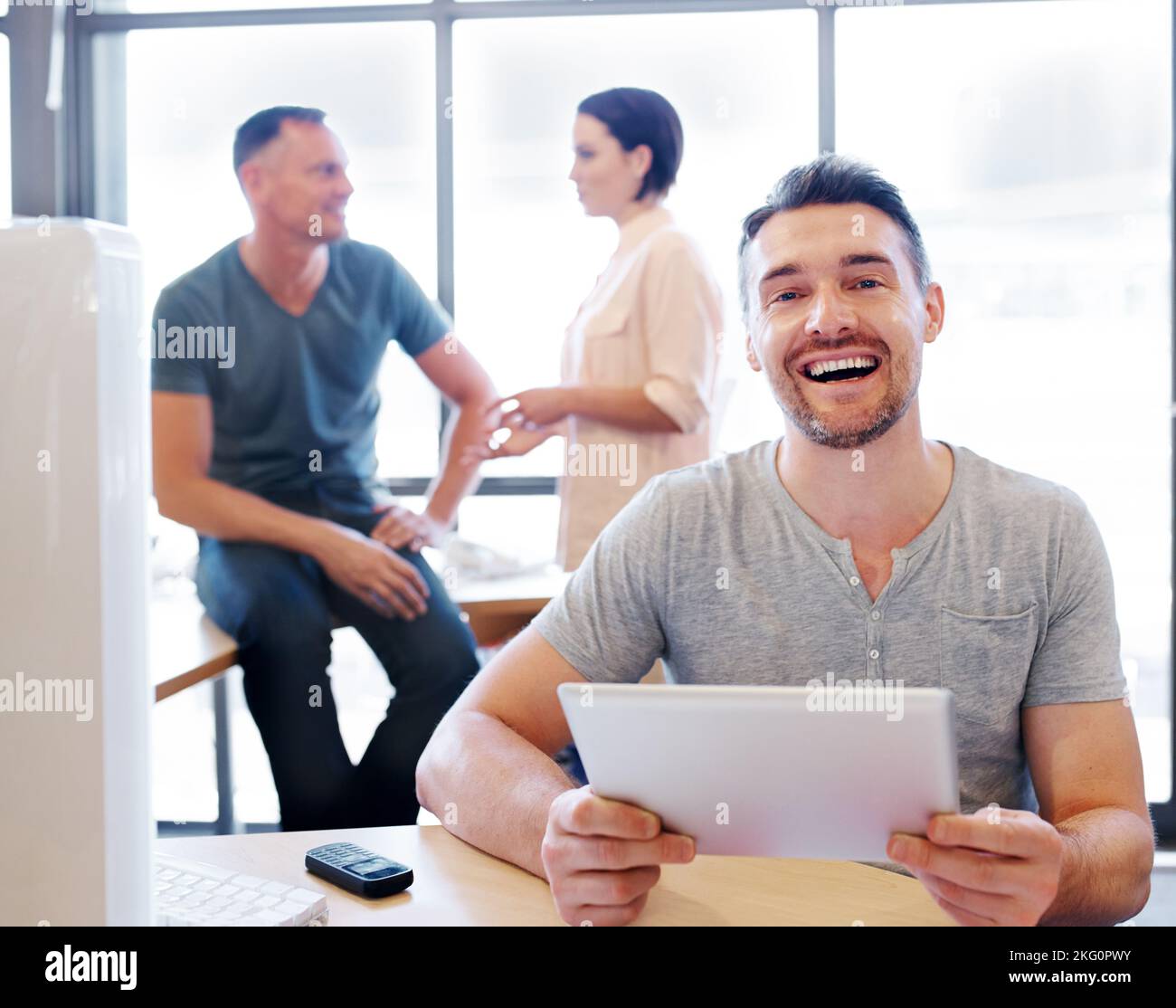 The infamous workplace LOL. Portrait of an office worker using a tablet ...