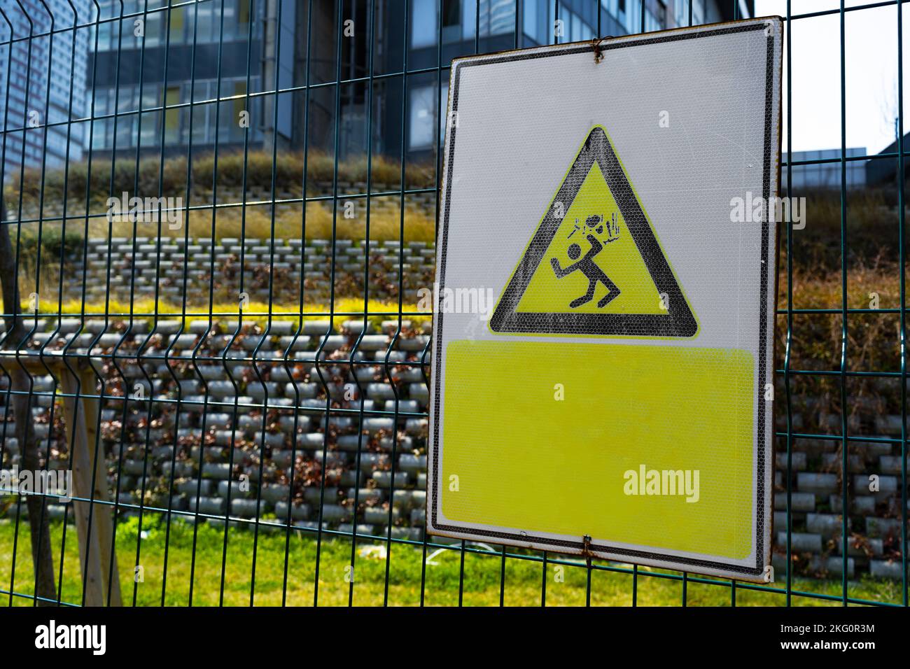 Yellow electric safety sign outside on metal gate Stock Photo - Alamy