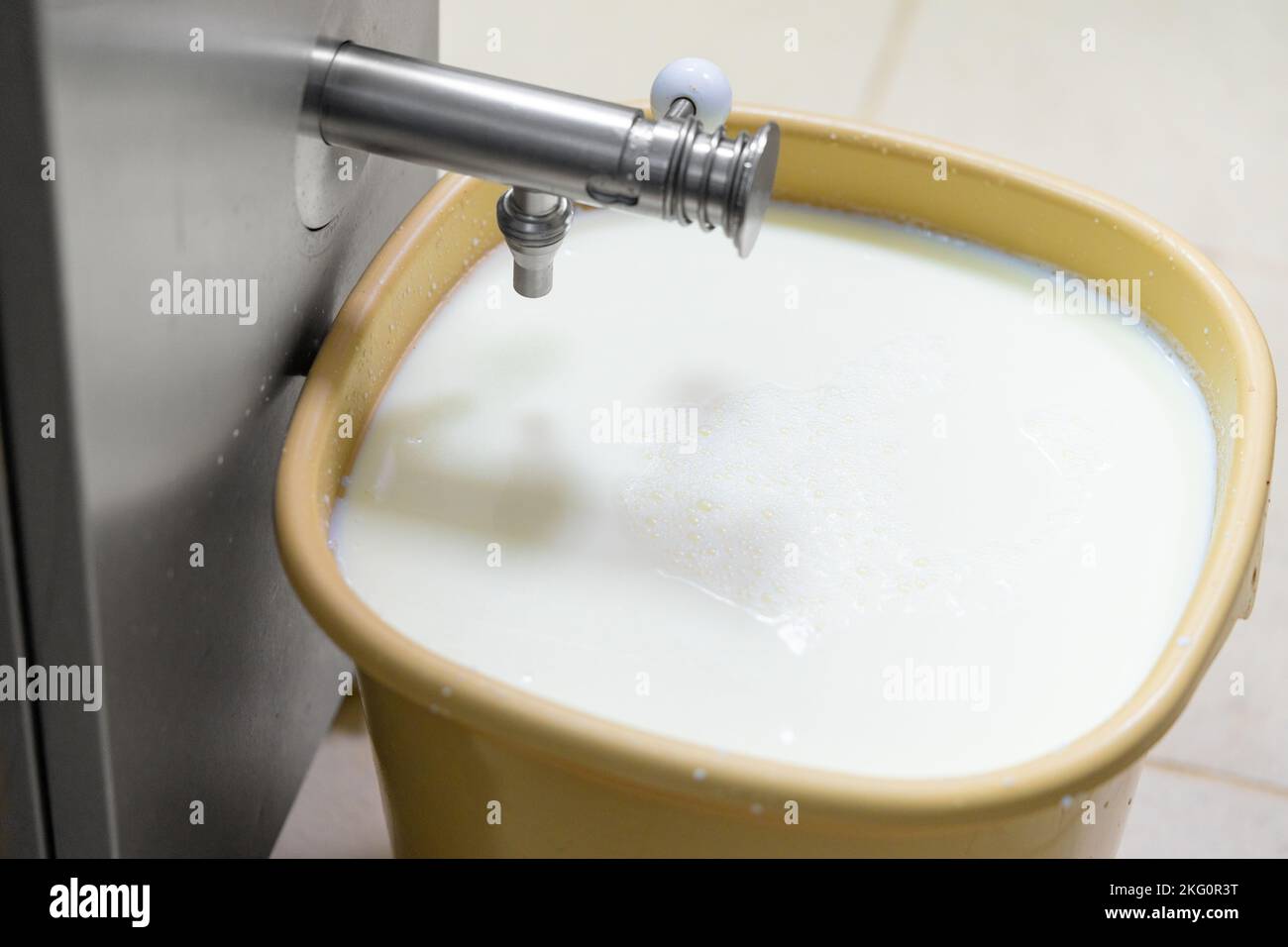Tap filled foamy water into a plastic bucket Stock Photo - Alamy