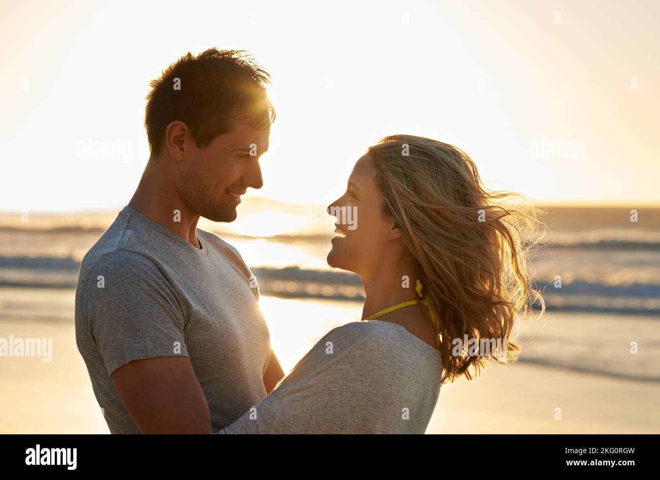 I love her eyes more than the sunrise. Closeup shot of a couple locked in a warm embrace along ...