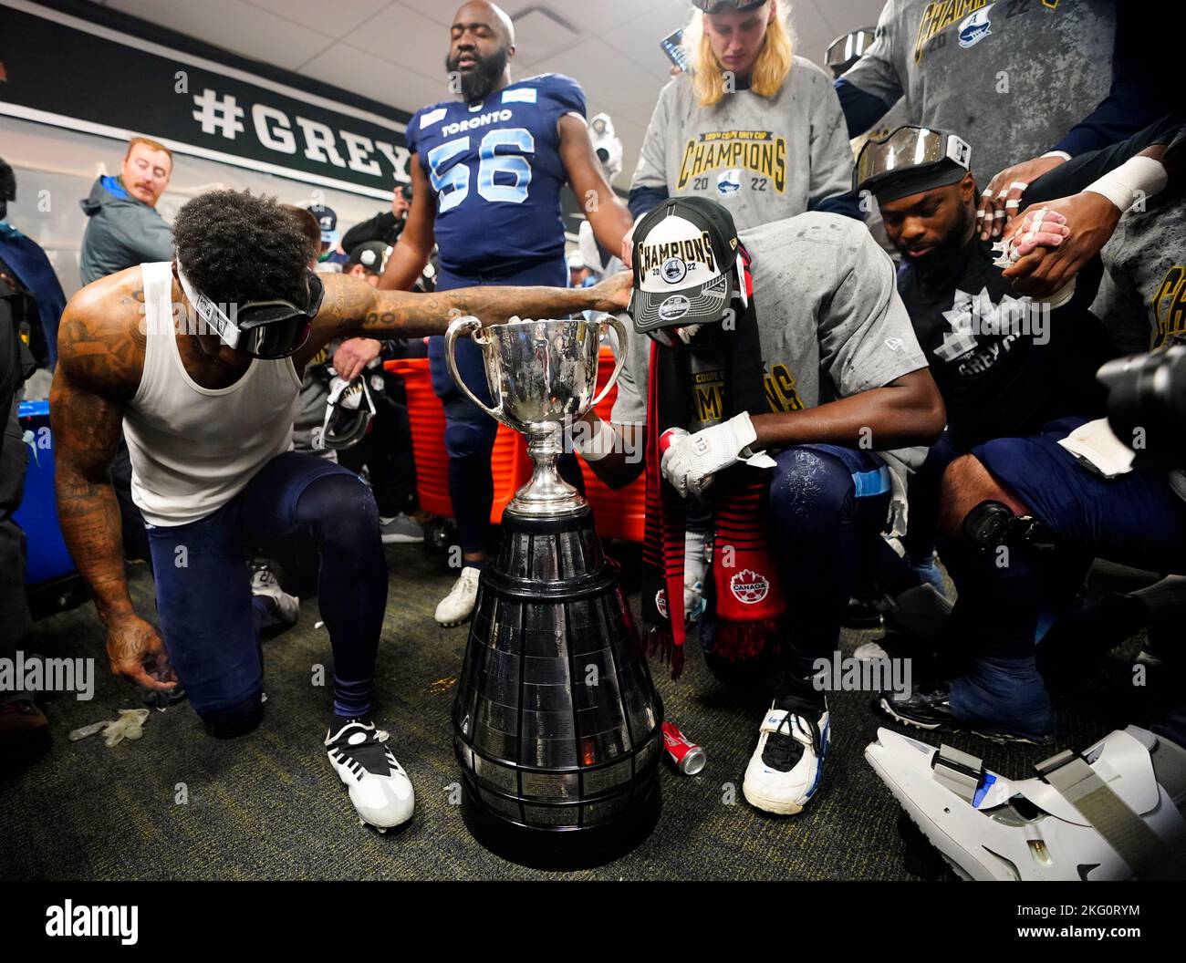 Members of the Toronto Argonauts pray around the Grey Cup as they celebrate defeating the ...