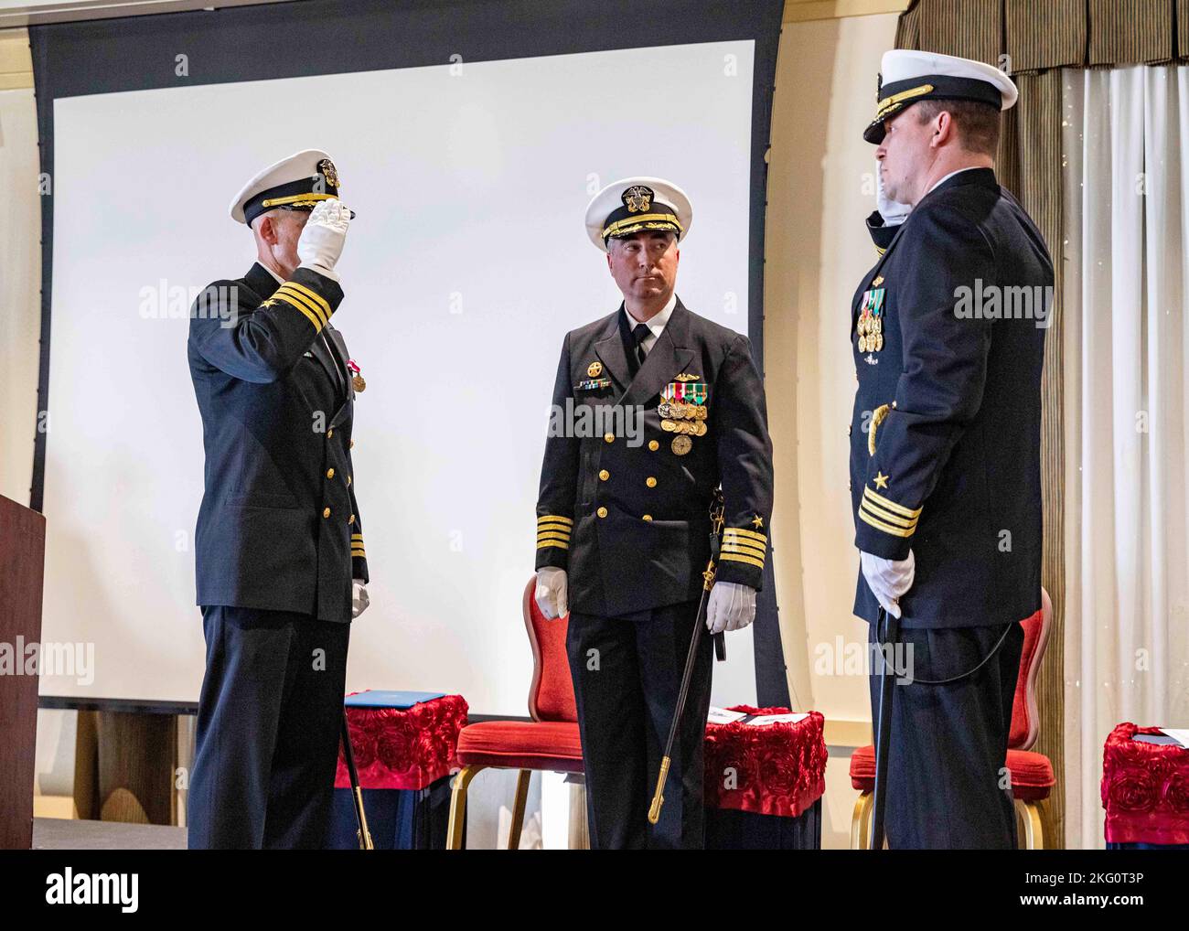 Capt. Brian Hogan, commodore, Submarine Squadron Eight, center, watches ...