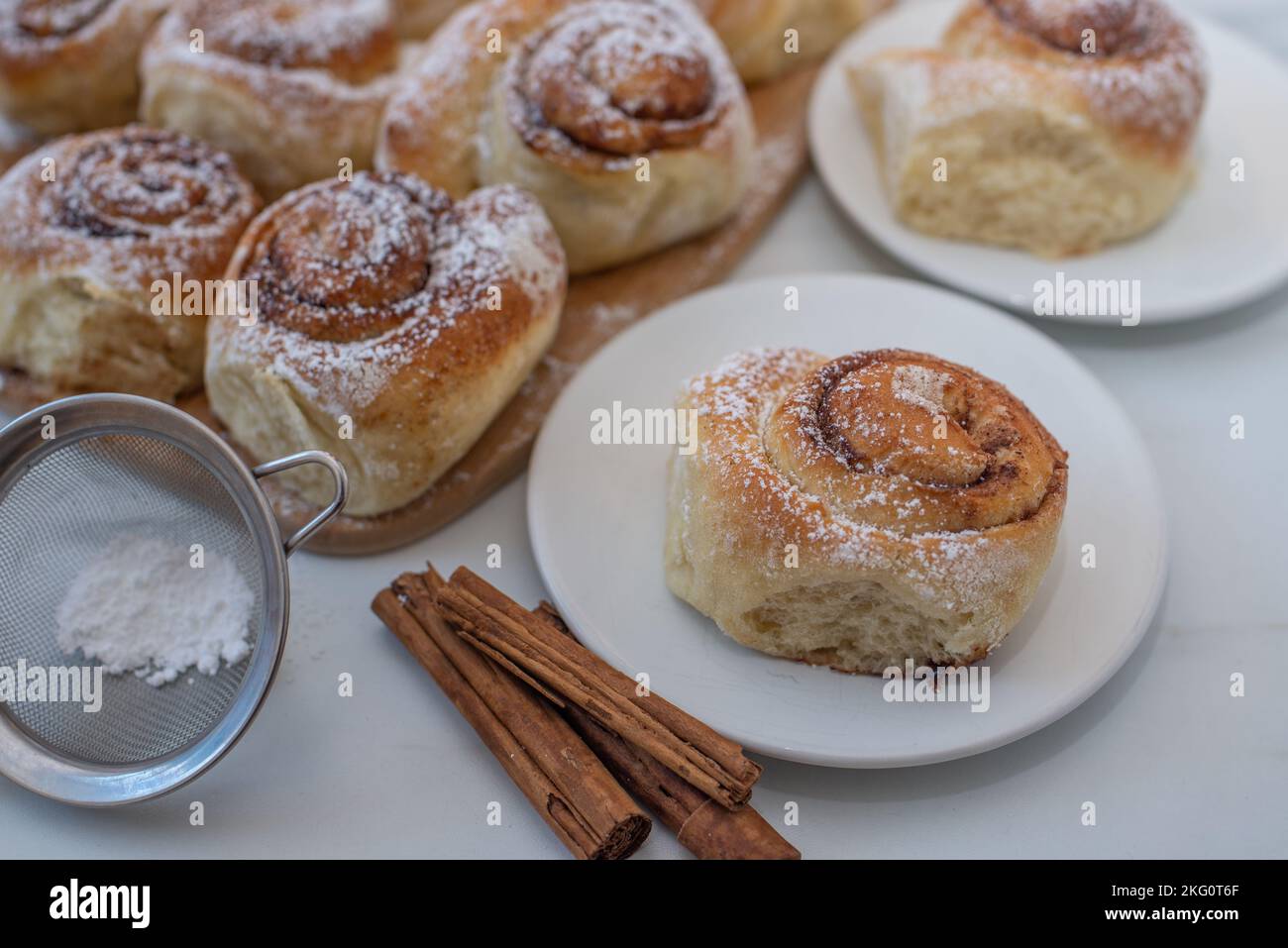 Cinnamon buns. Beautiful fresh cinnamon rolls on a table Stock Photo ...
