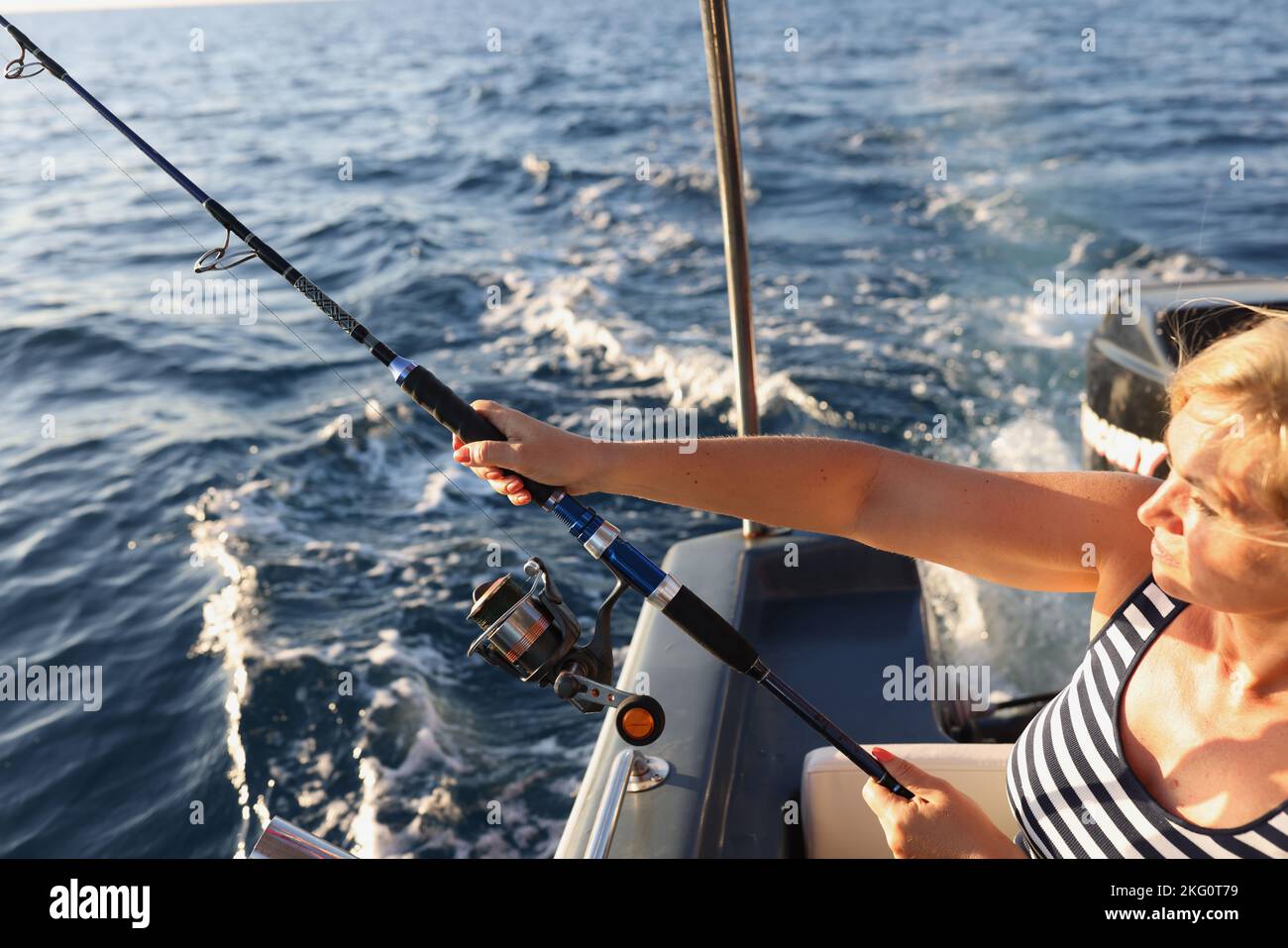 Hand holding fishing pole hi-res stock photography and images - Alamy