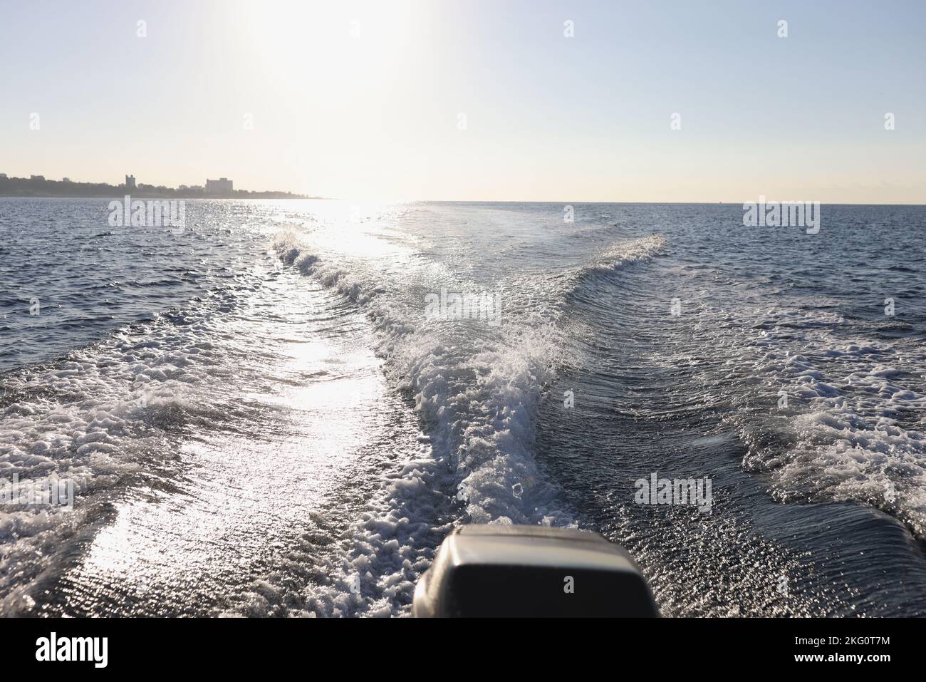 Outboard motor wake from cruising powerboat on sea Stock Photo - Alamy