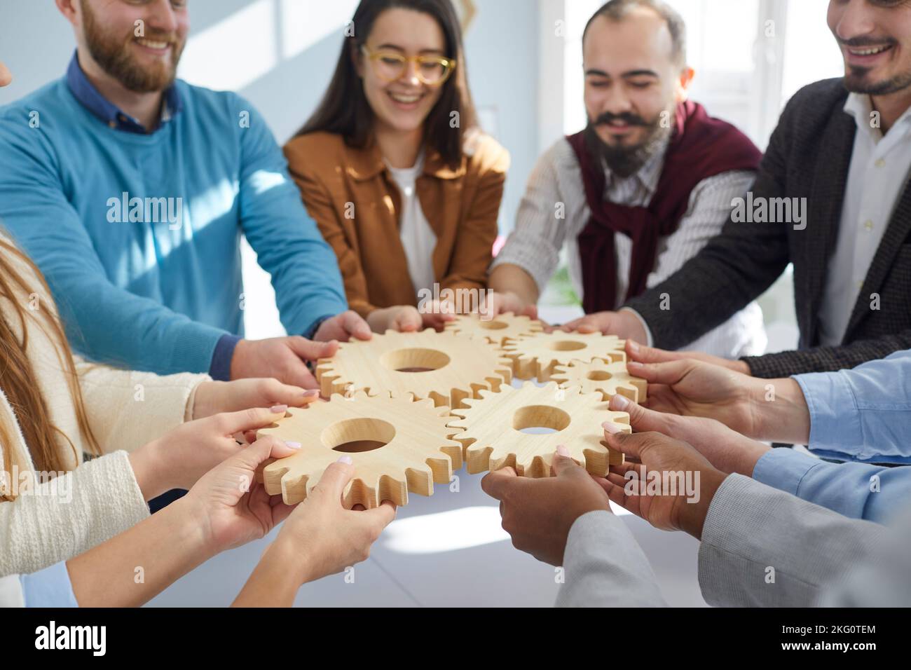 Business people hands connecting gear cog, concept of coopertation ...