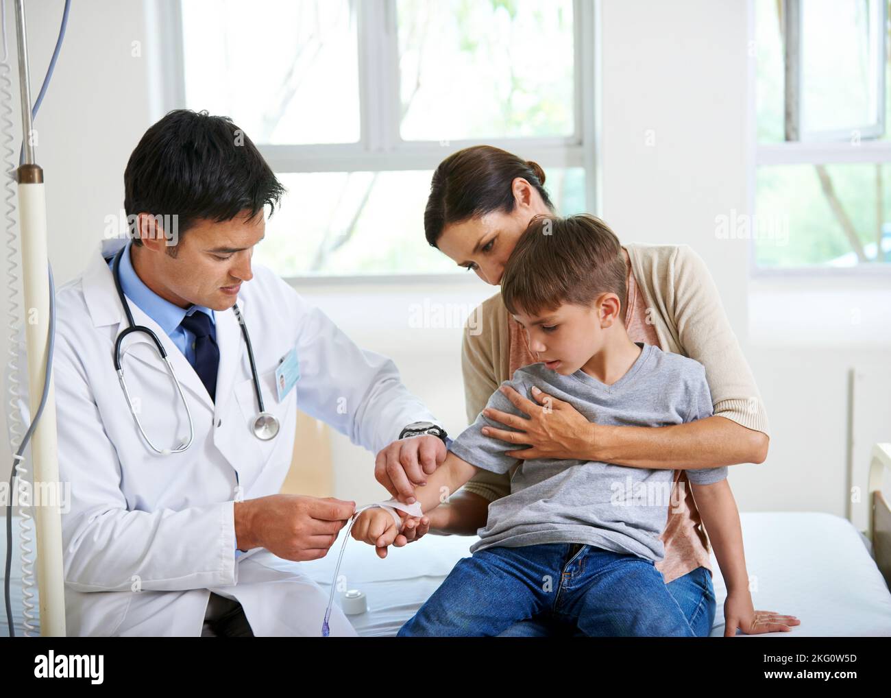 Unleashing the Superman within. a doctor placing an IV in his young ...