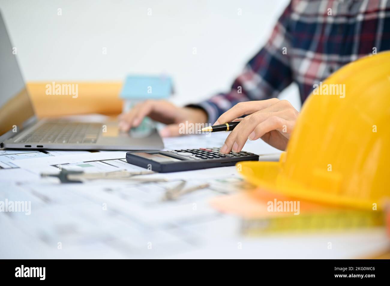 Professional Asian female architect or engineer using scientific ...