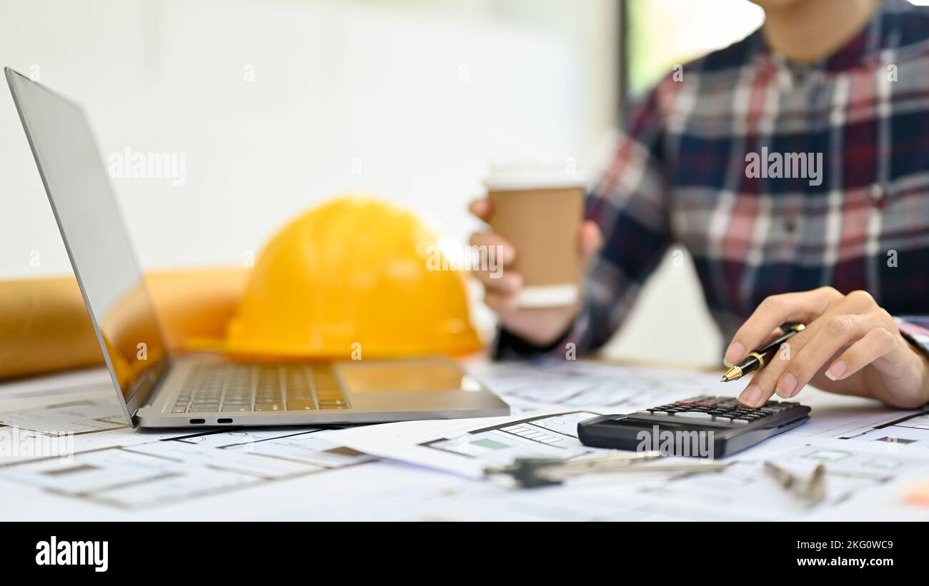 Professional and determined Asian male engineer or architect using ...