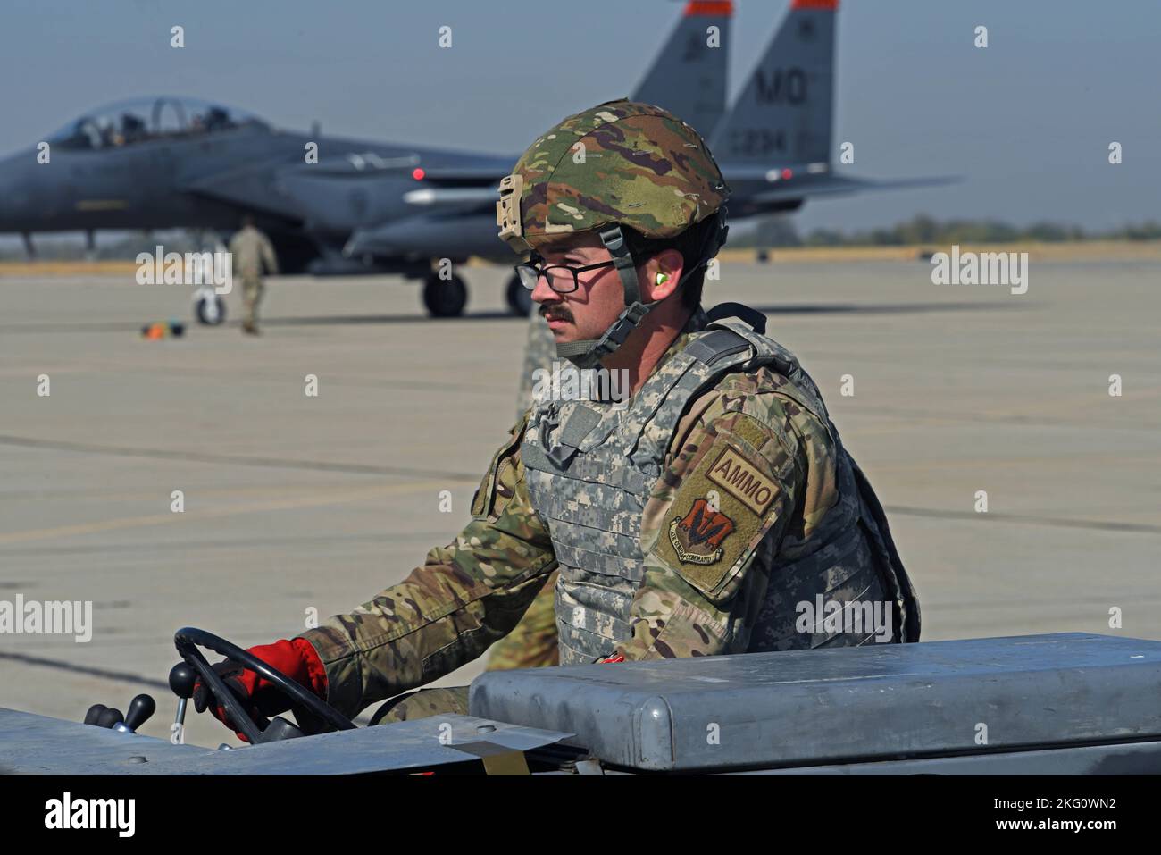 A U.S. Airman with the 366th Munitions Squadron prepares to transport munitions to an F-15E ...