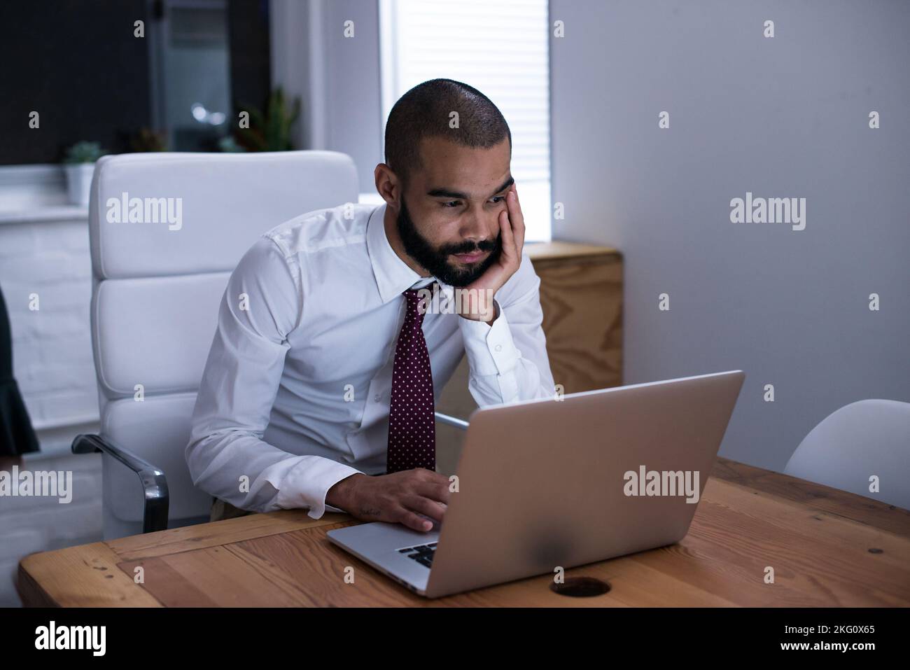 Logging in the extra hours Stock Photo - Alamy