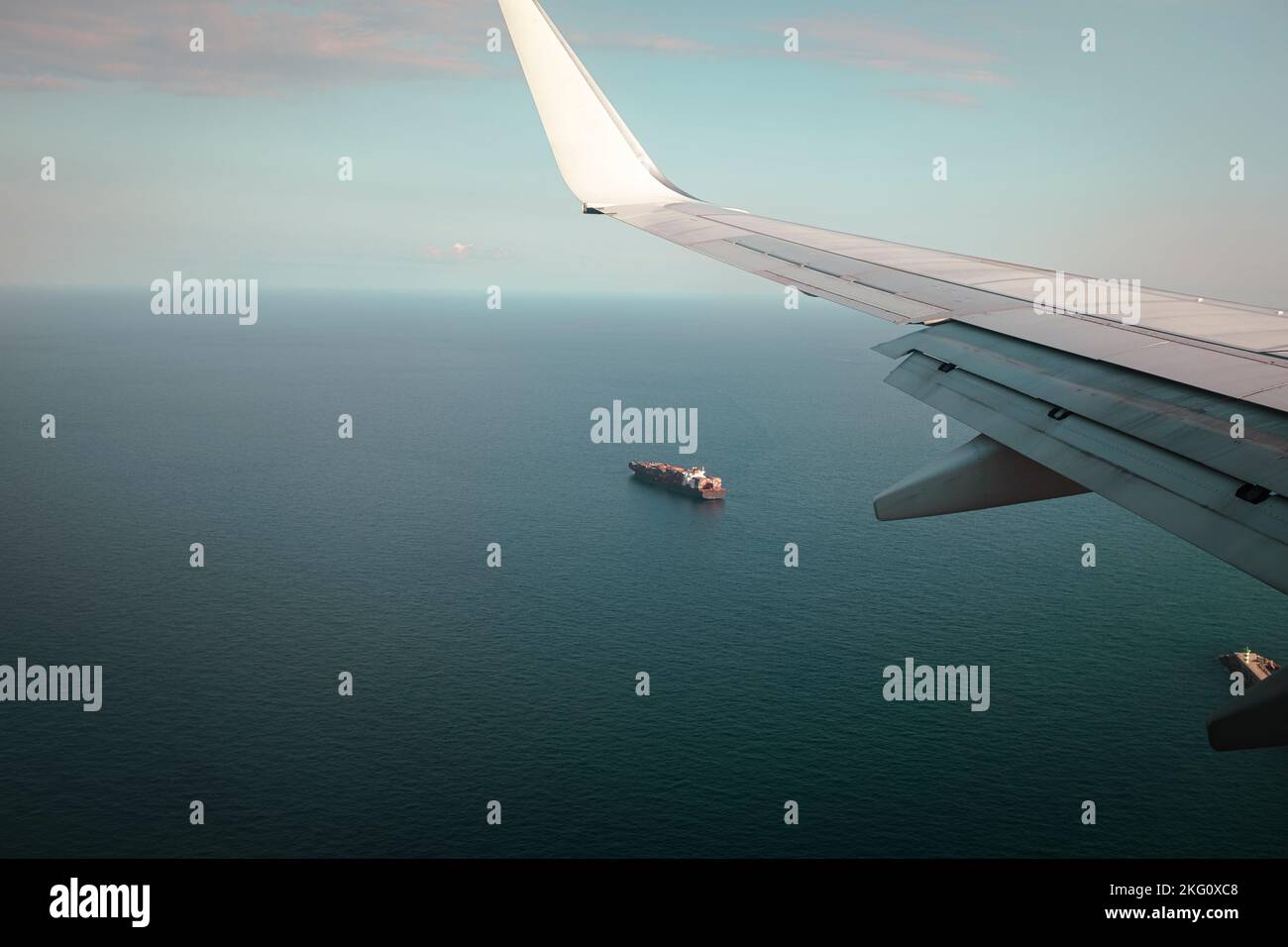Cargo freight ship on a plain sea landscape seen from an airplane ...
