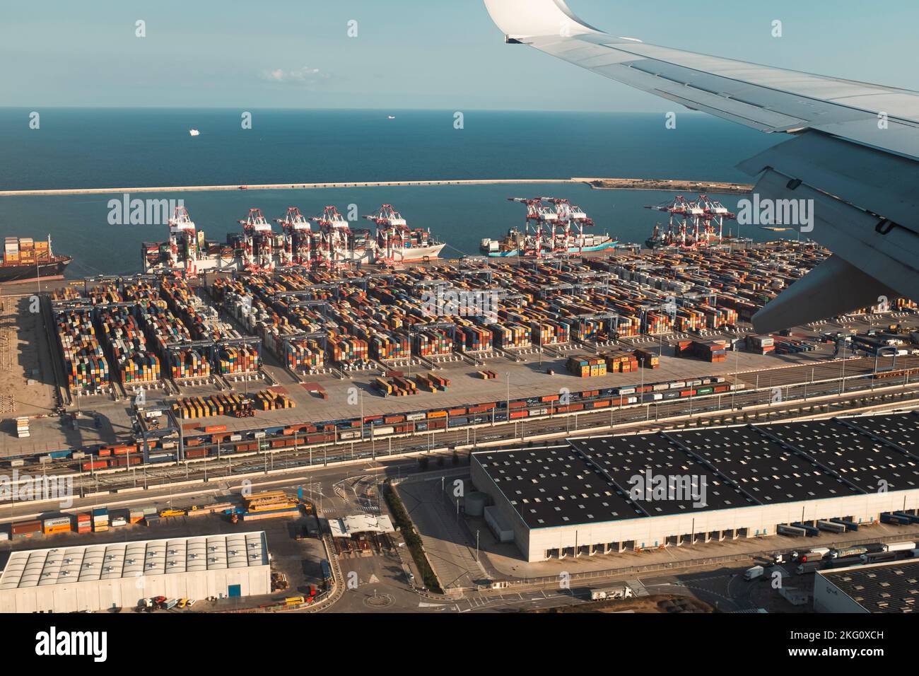 Many cargo containers and fright boats on a harbour seen from an ...