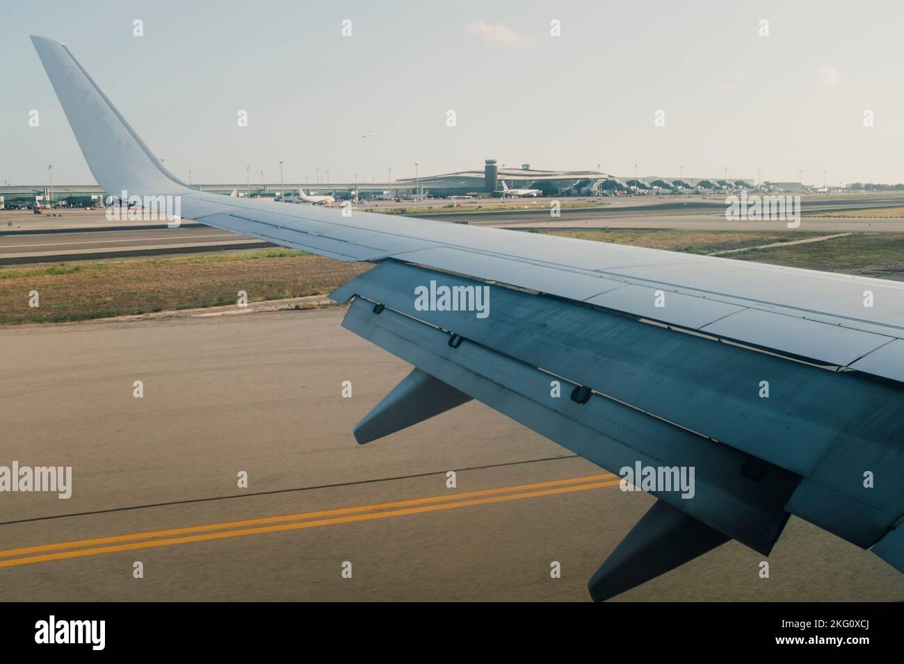 Airplane wing with open flaps landing on an airport track Stock Photo ...