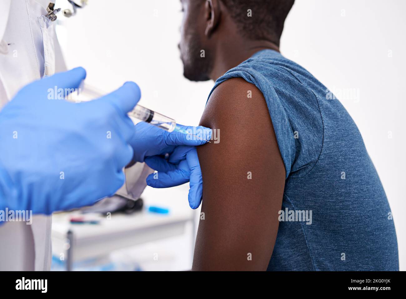 Getting vaccinated before winter. a male patient getting an injection ...
