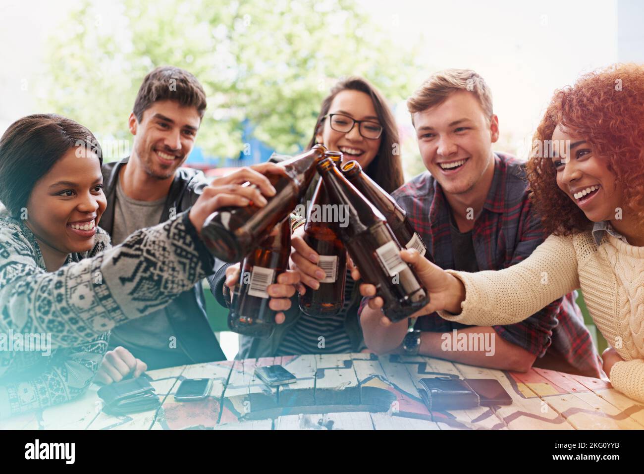 Cheers to friendship. a group of friends drinking outdoors Stock Photo ...